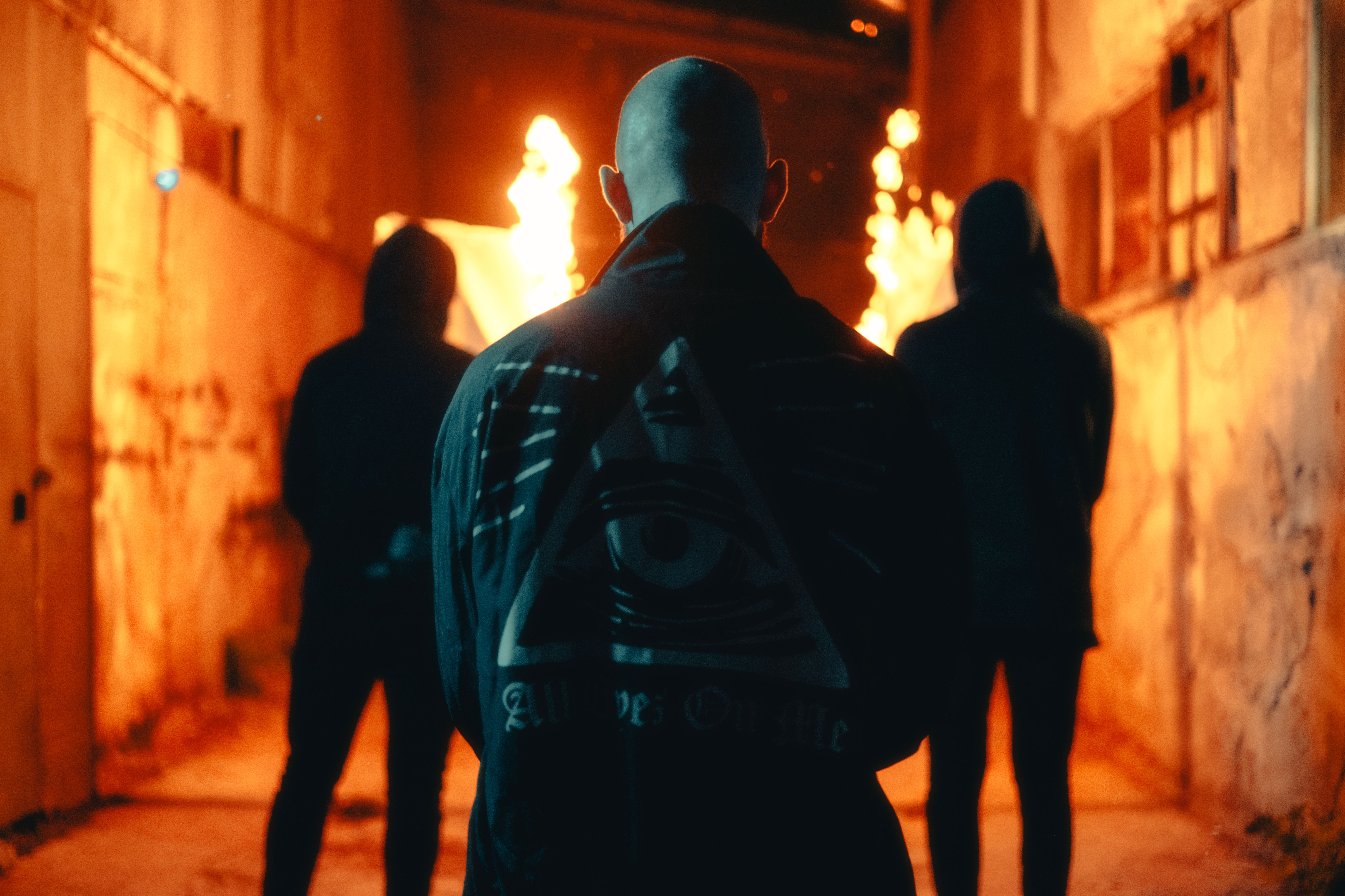 Fire and Flames behind Men Standing in Alley at Night · Free Stock Photo