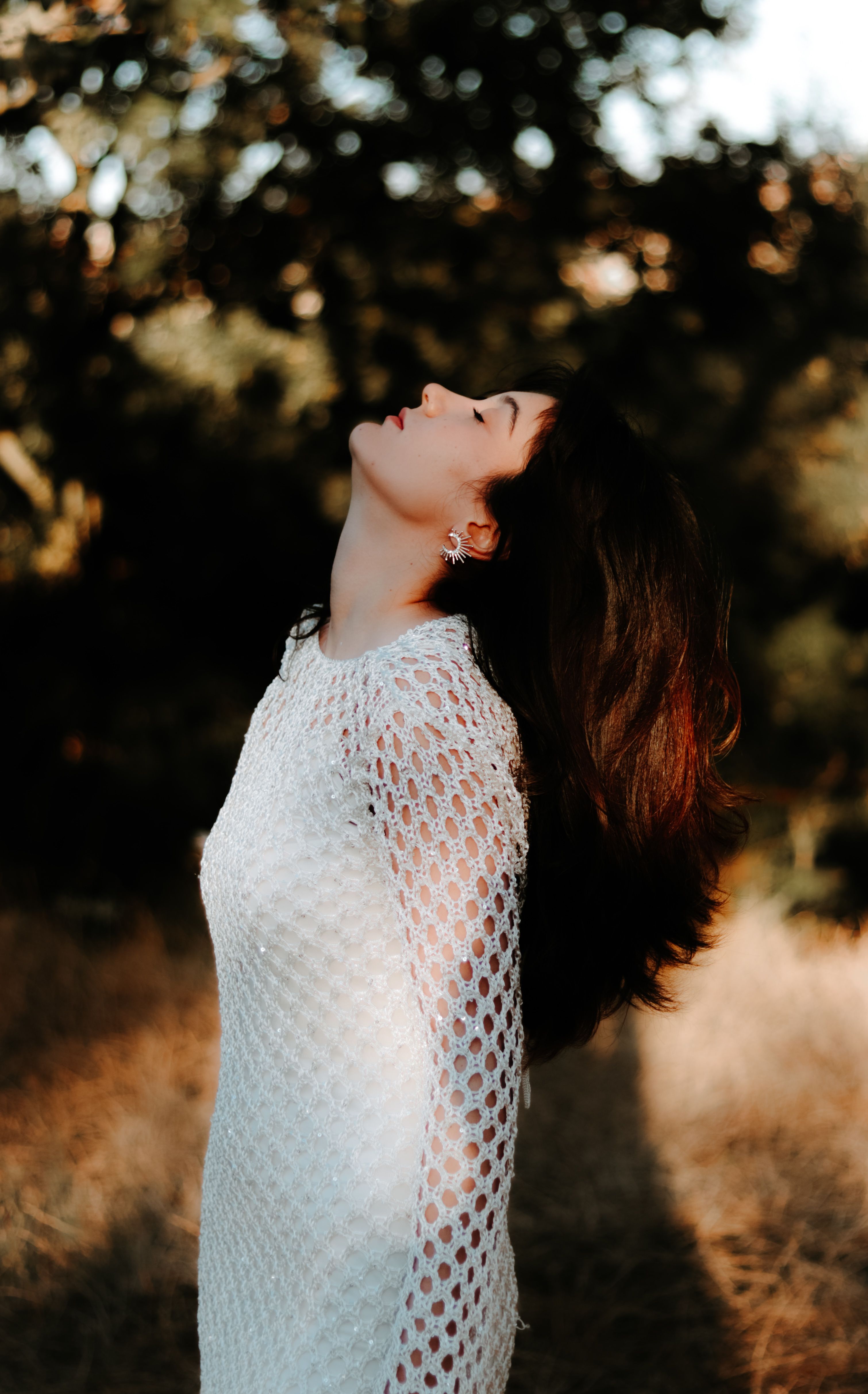 Model Posing in White Clothes and with Eyes Closed · Free Stock Photo