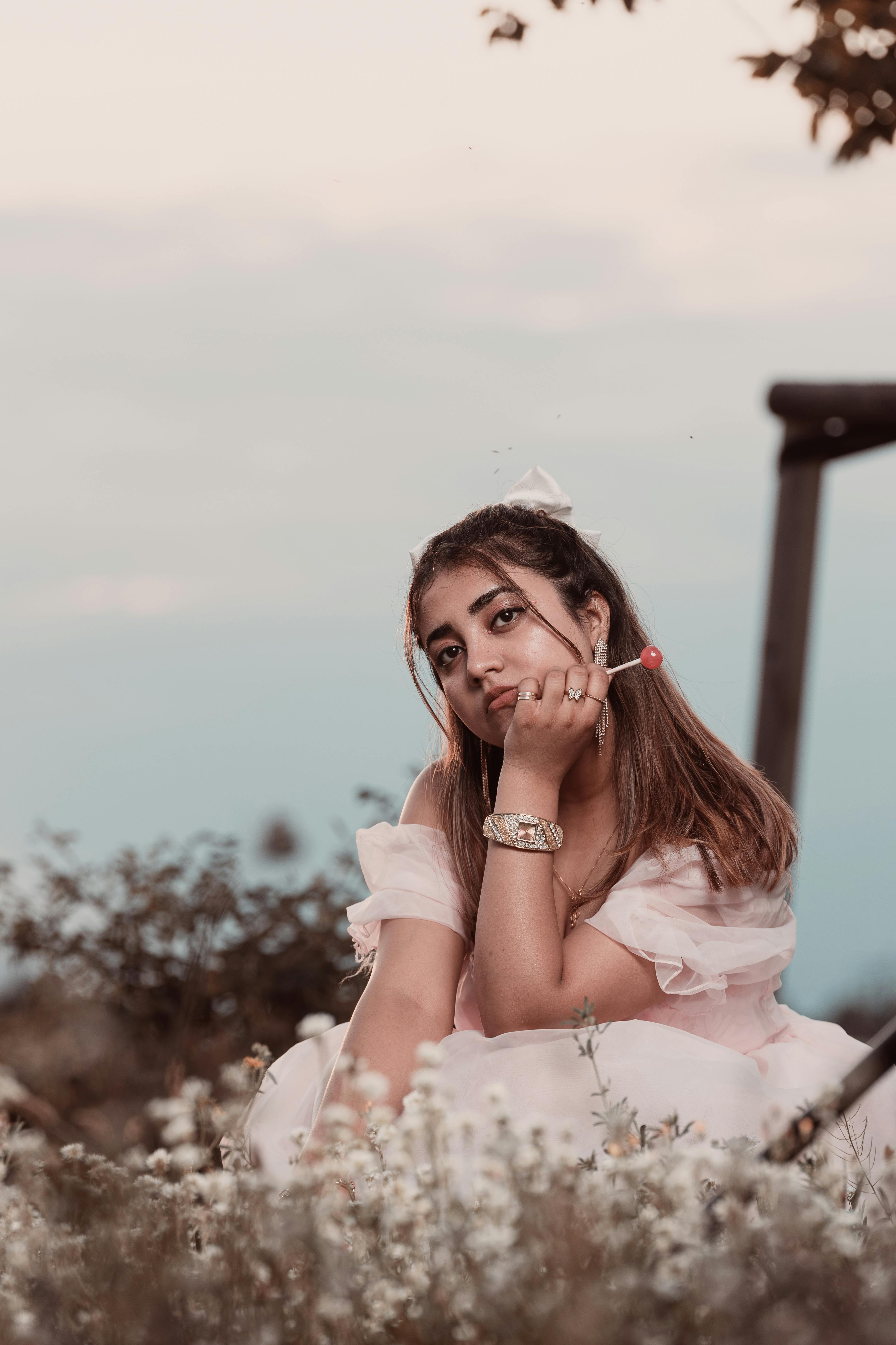 Blonde Woman in White Dress Squatting among Flowers on Meadow · Free ...