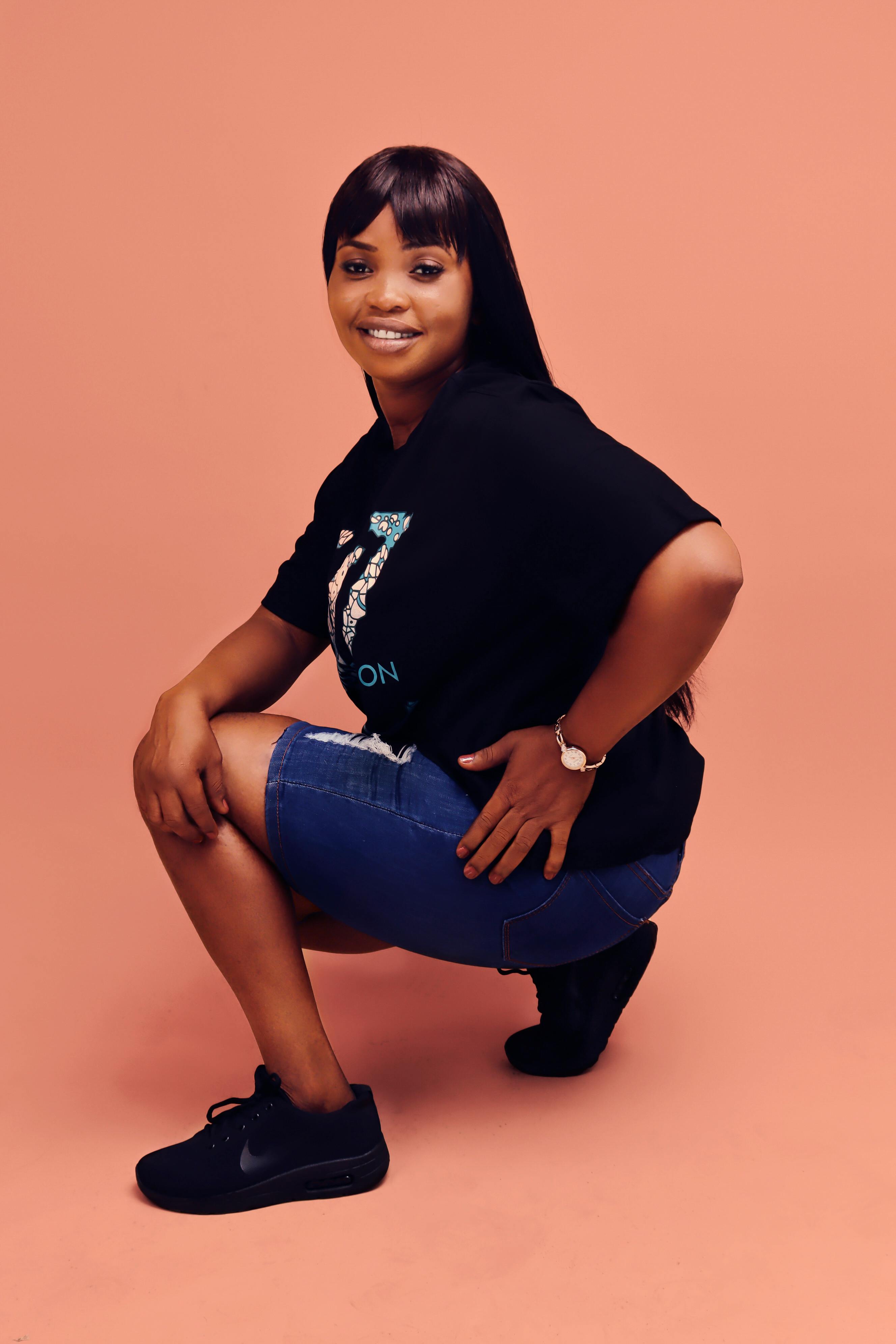 Smiling Model Squatting and Posing · Free Stock Photo