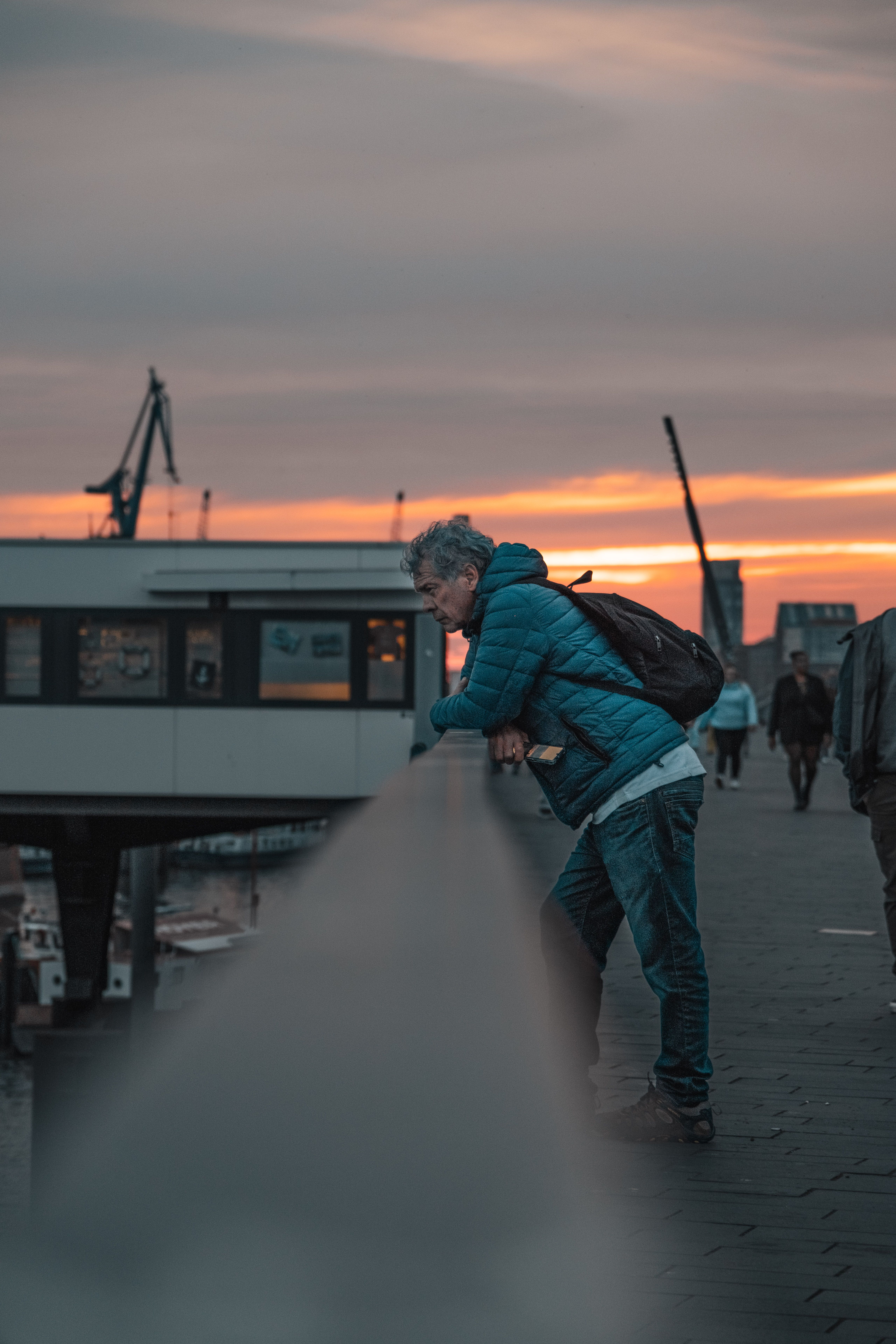 Man Standing on a Bridge at Sunset · Free Stock Photo