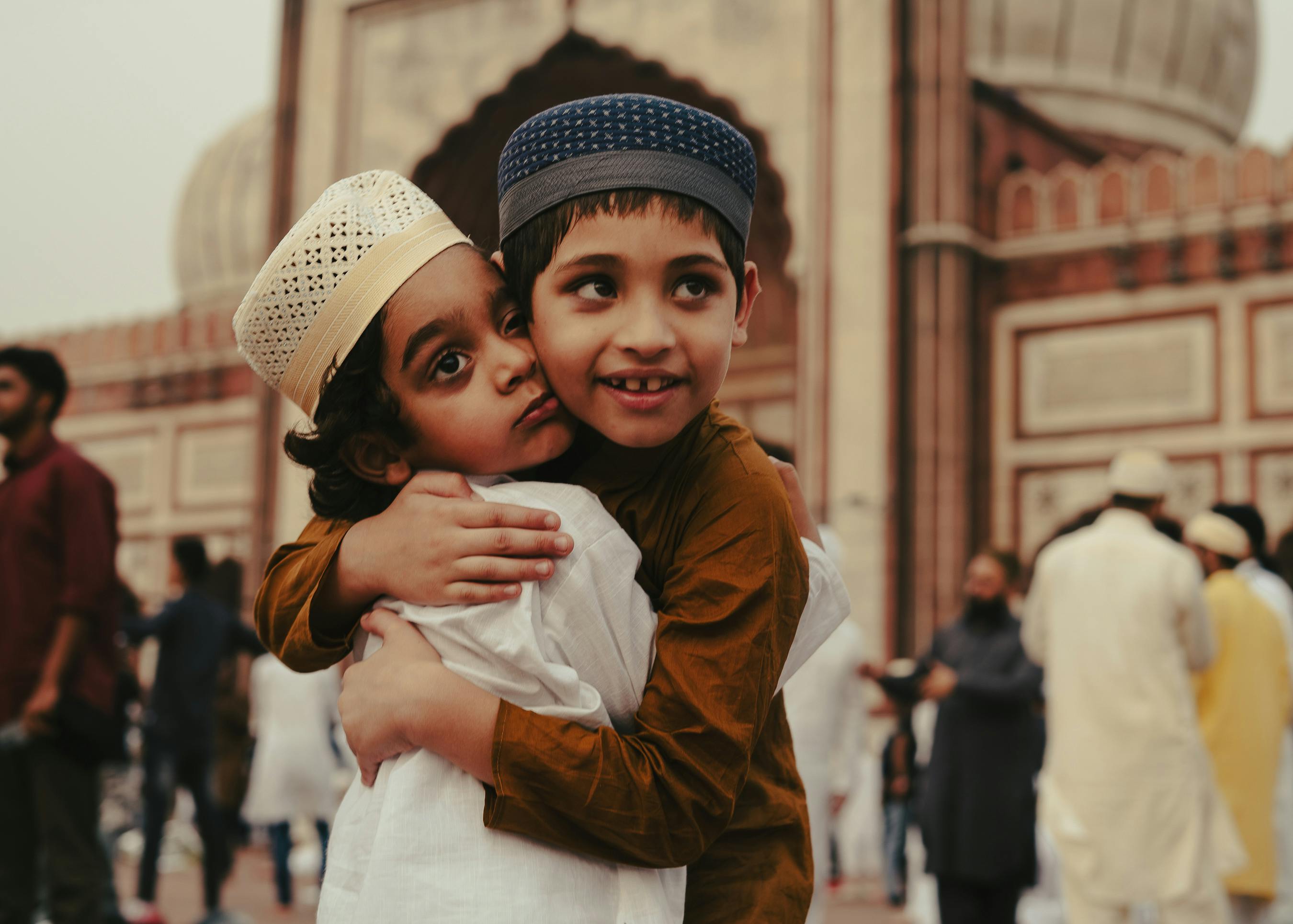 Children Hugging in the Square in Front of the Mosque · Free Stock Photo