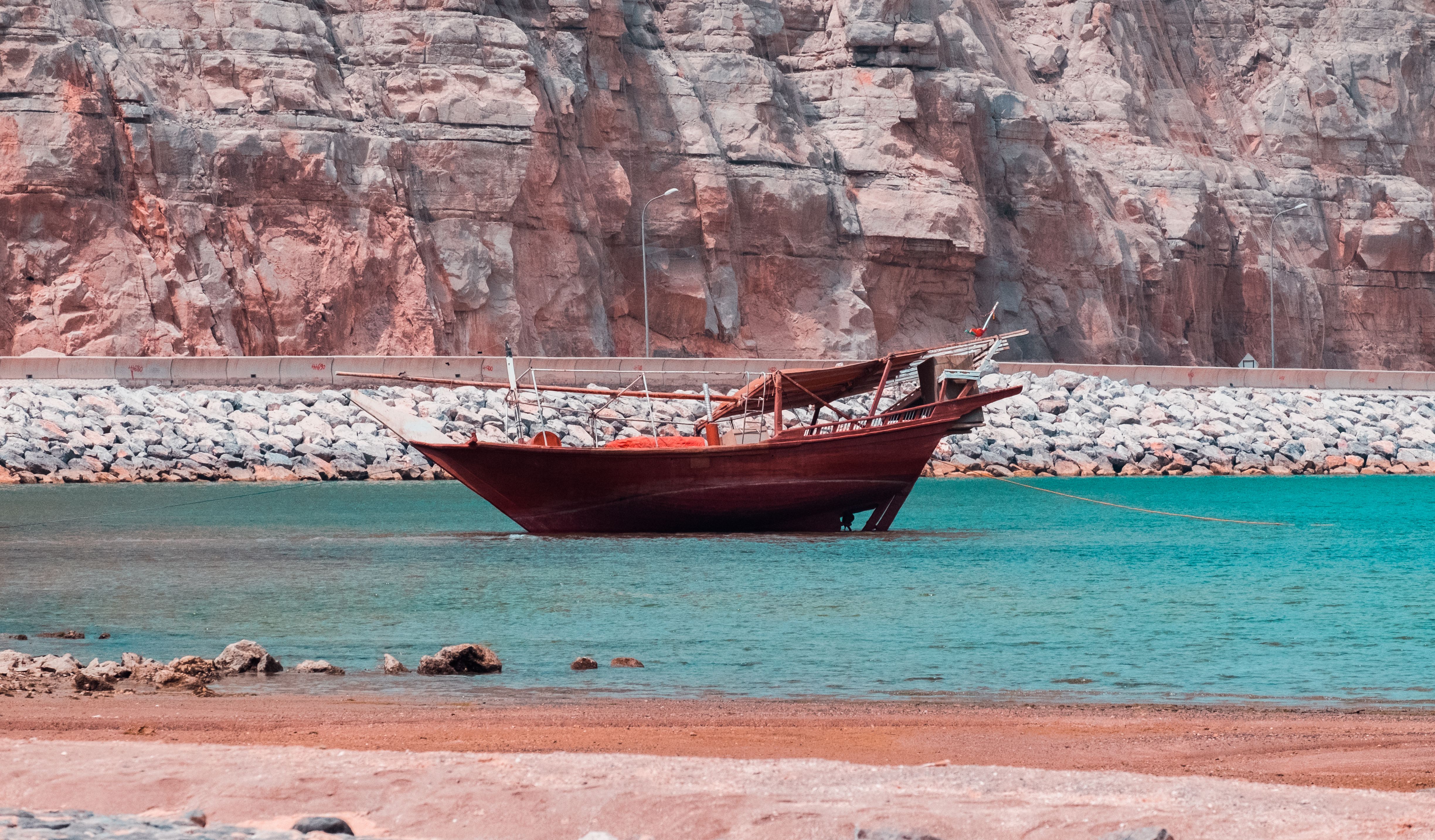 Boat Moored on Lake with Rocks behind · Free Stock Photo