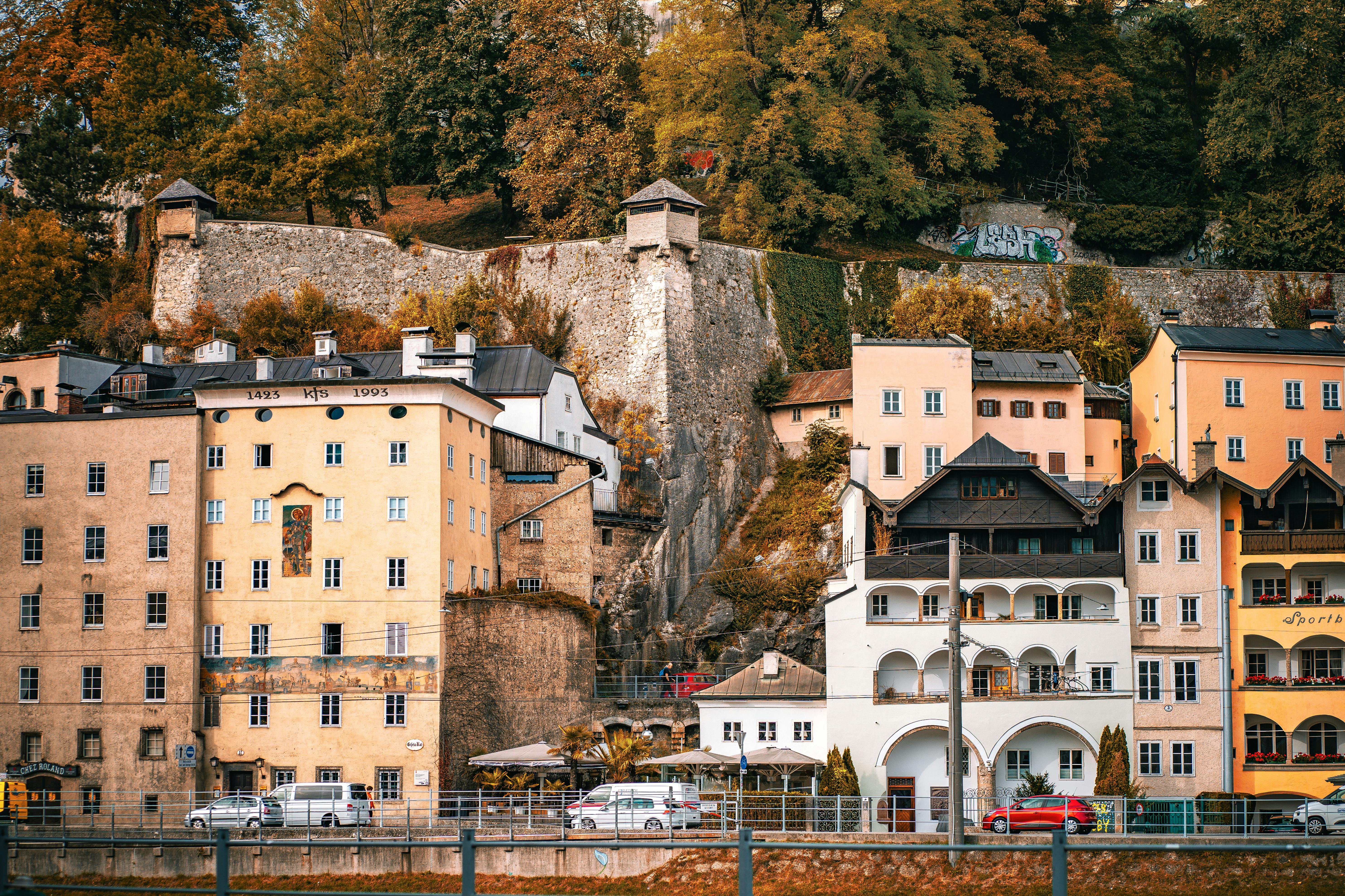 Facades of Buildings in a Hill with a Fortress and Autumnal Trees ...