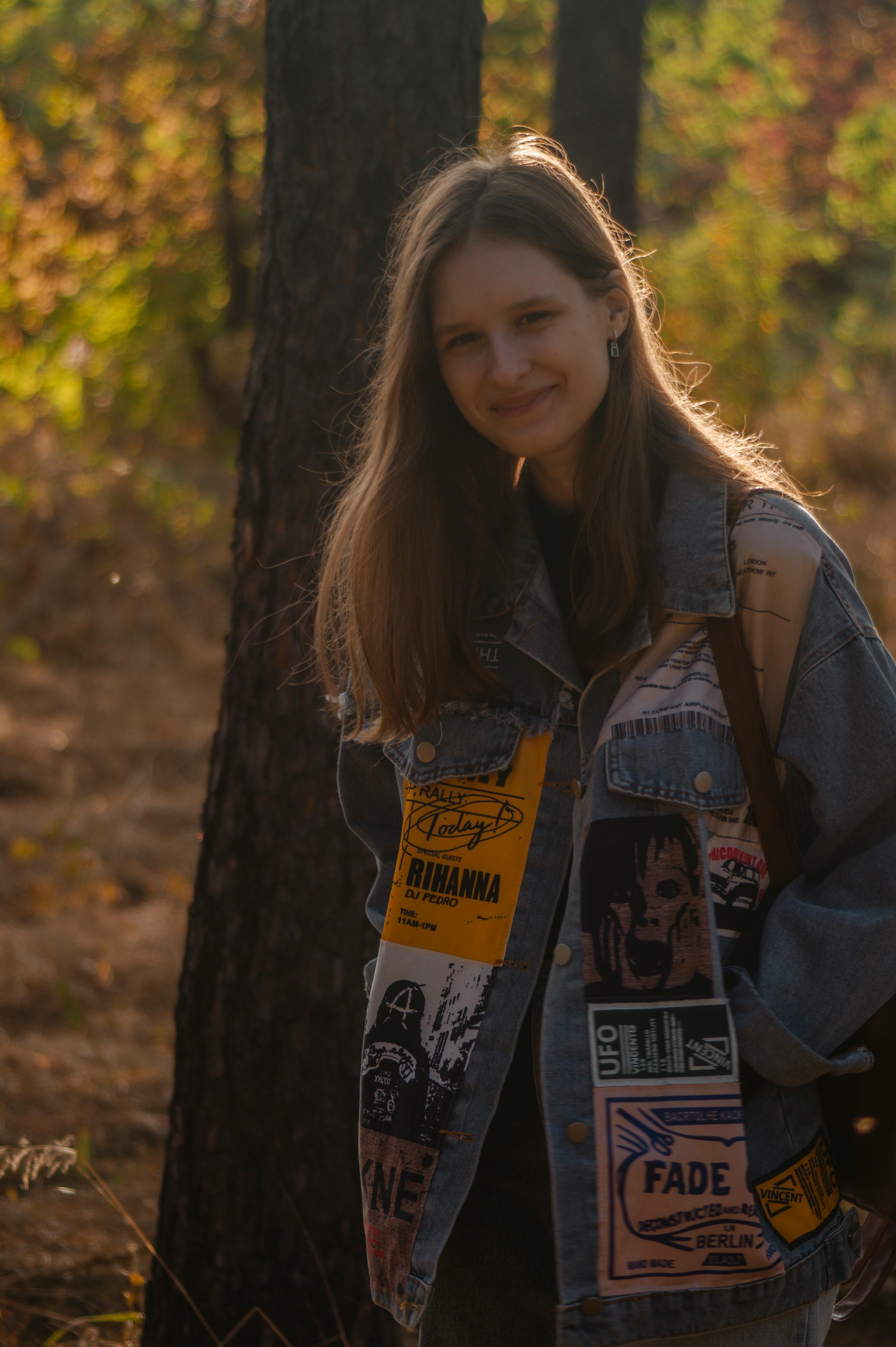 Brunette Woman in Denim Jacket Standing by Tree · Free Stock Photo