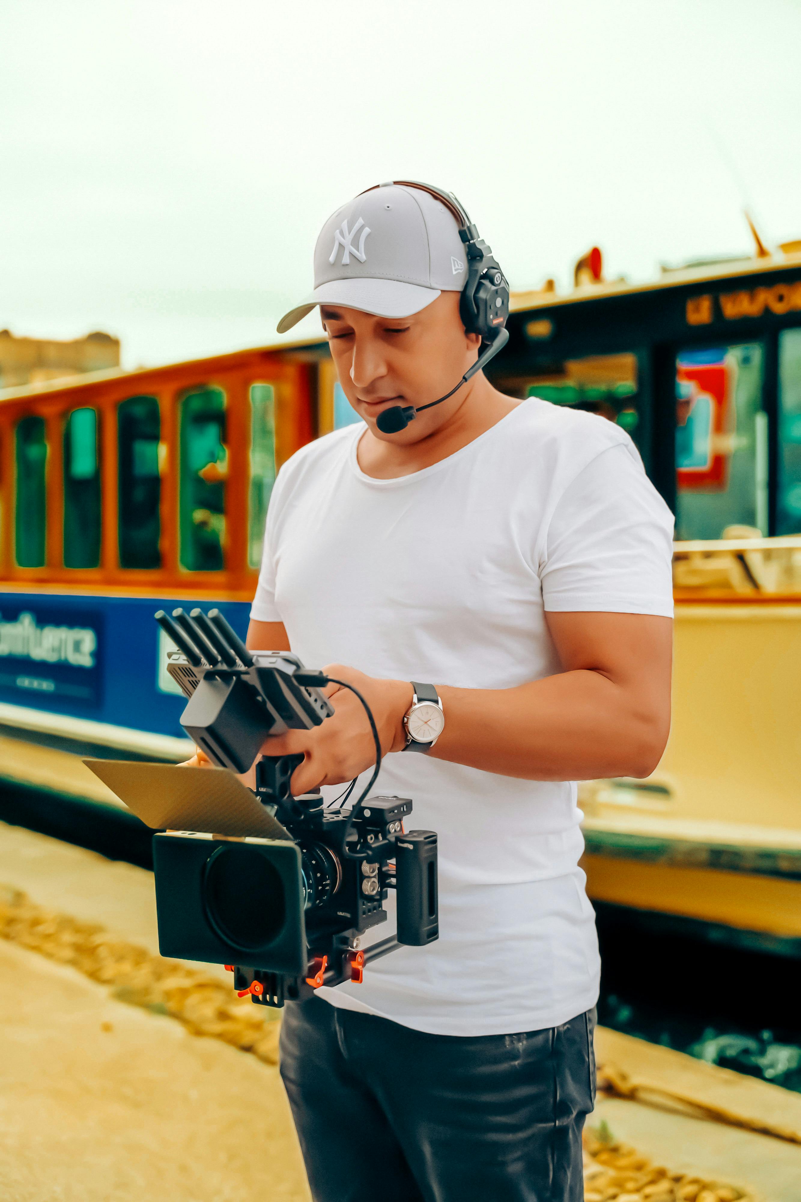A Camera Operator Wearing a Headset and Holding a Professional Camera ...