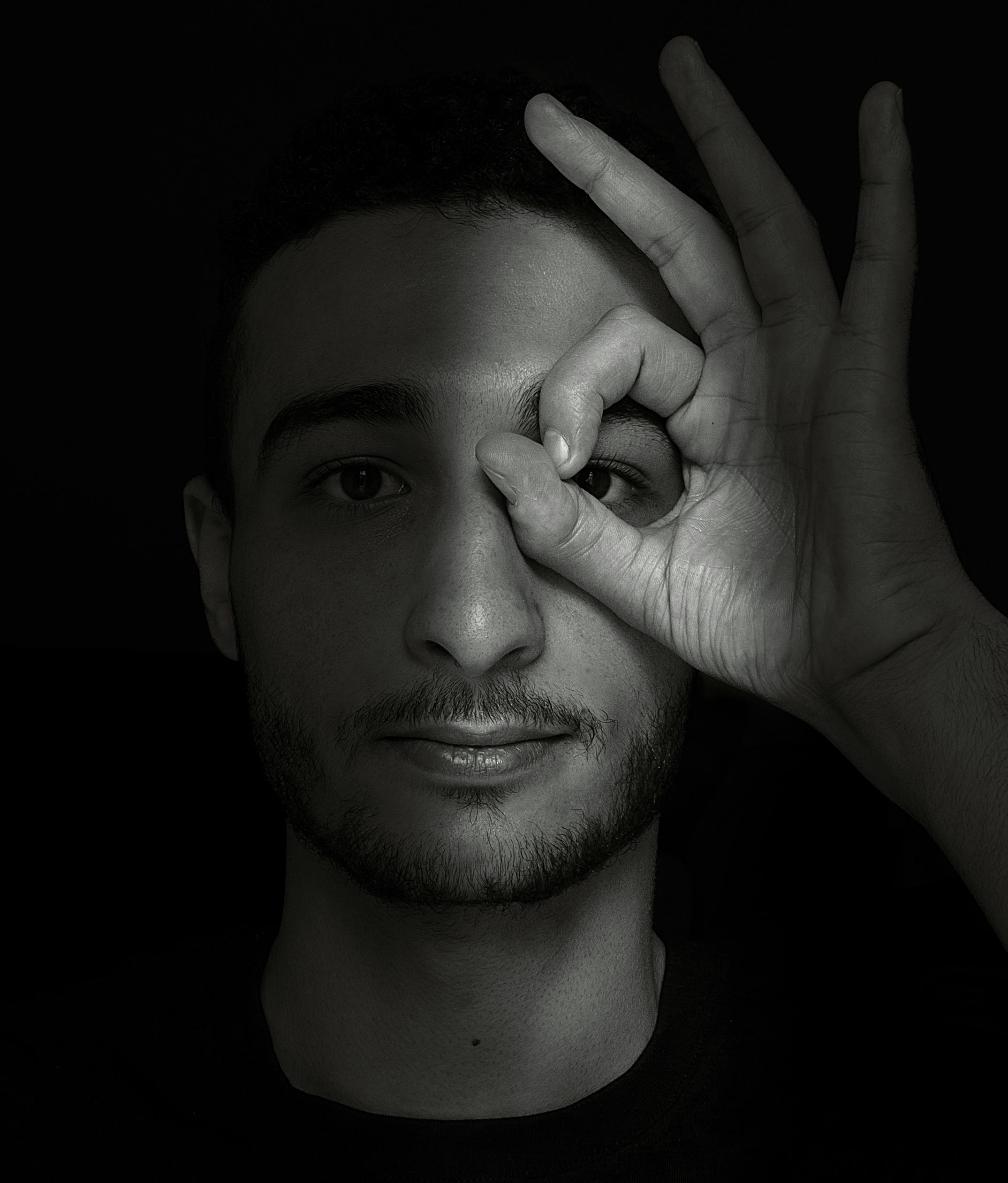 Man with Circle Gesture over Eye · Free Stock Photo