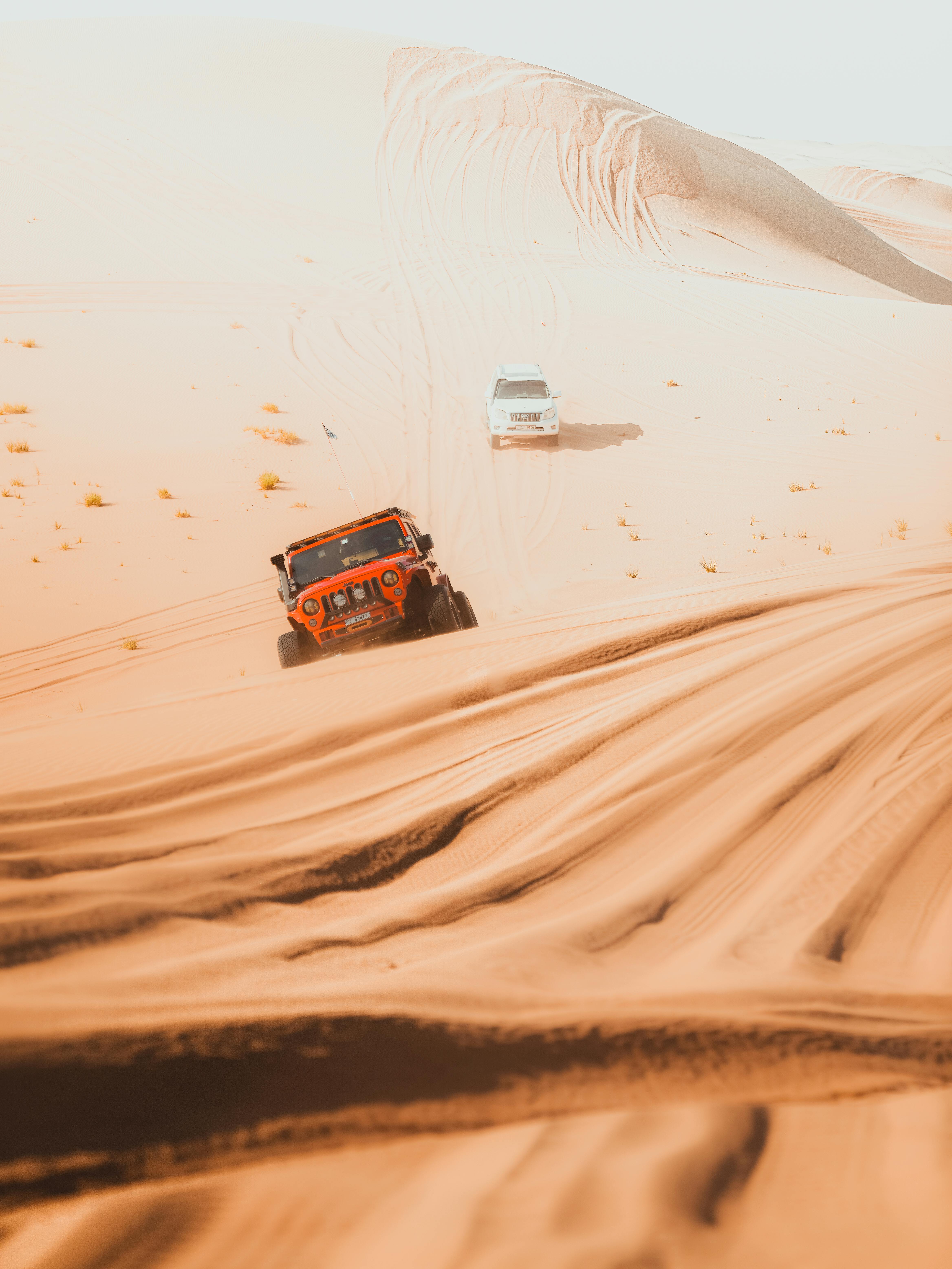 Red Jeep Wrangler on Desert Dune · Free Stock Photo