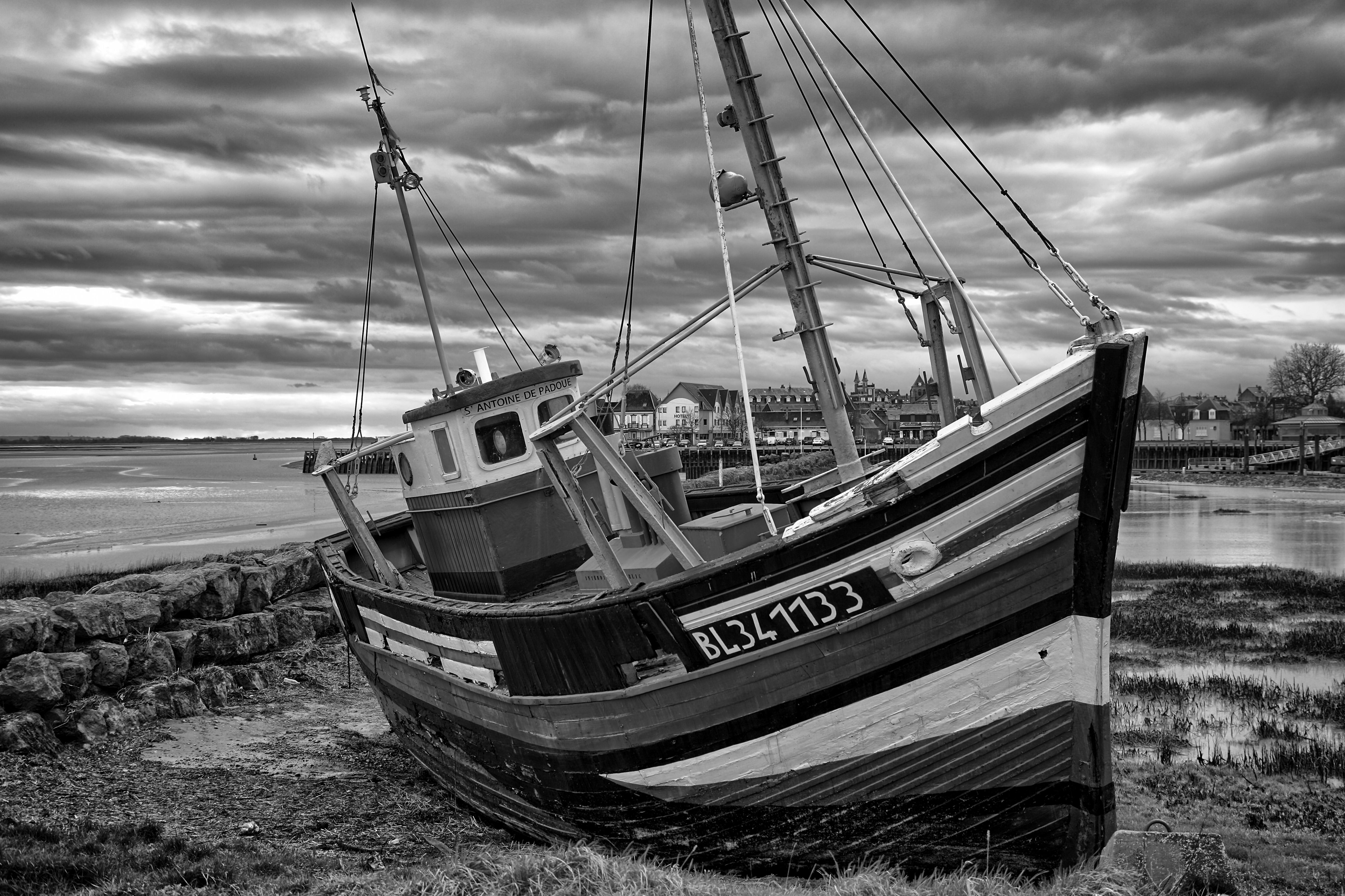 Black and White Photo of a Fishing Boat on a Shore · Free Stock Photo