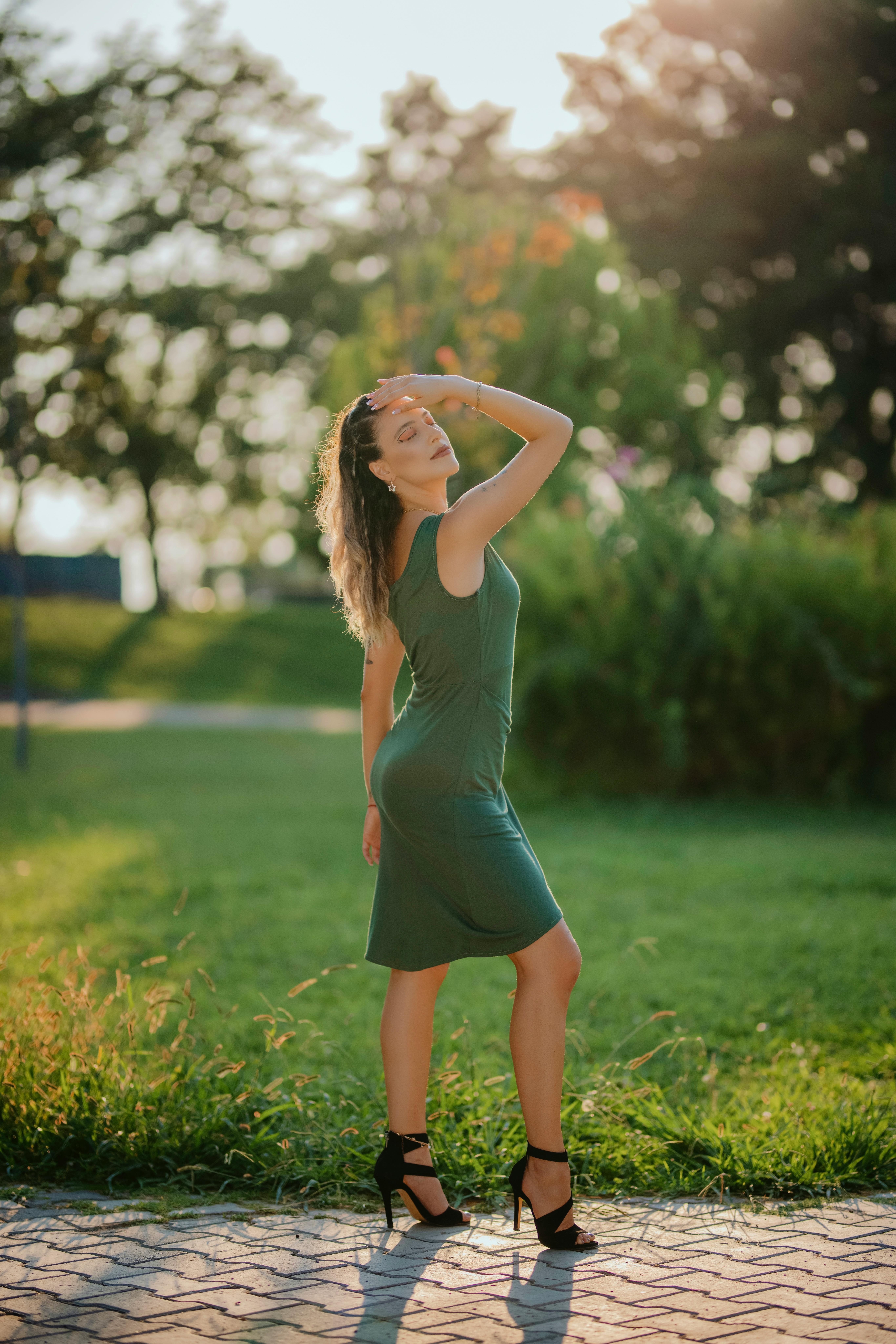 Model Posing in Green Dress in Park · Free Stock Photo