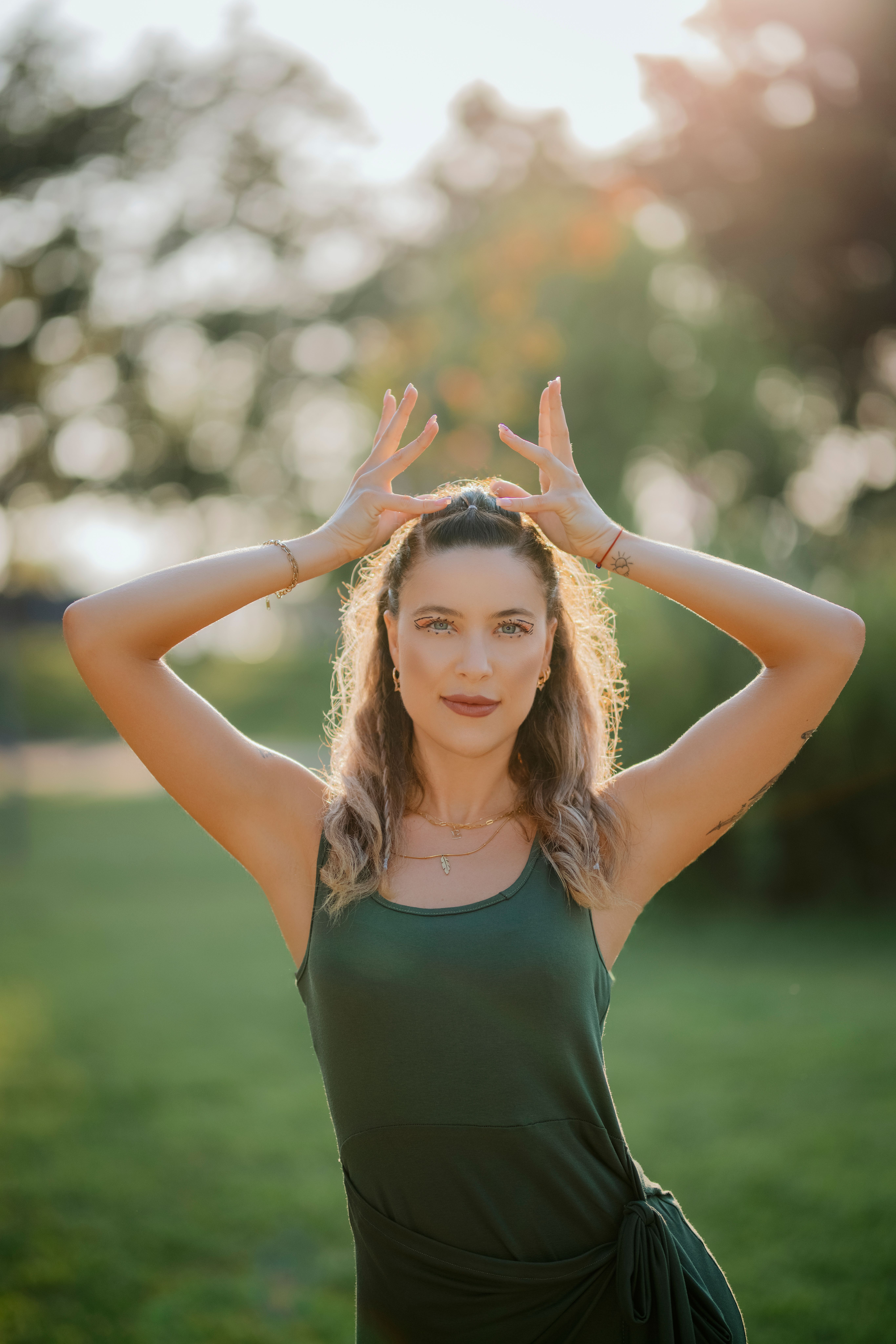 Model Posing with Arms Raised · Free Stock Photo