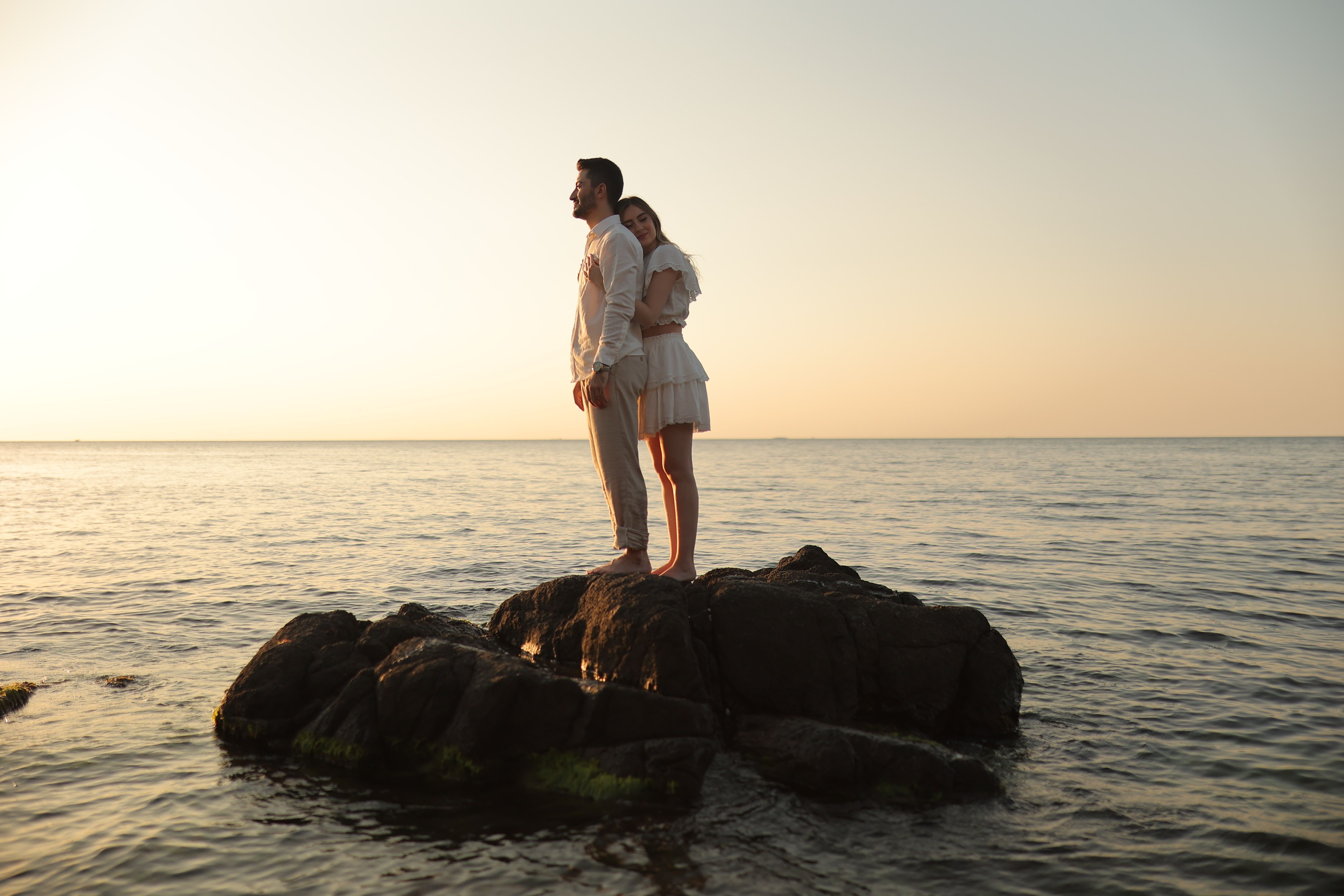 Couple Hugging on a Rock in a Sea · Free Stock Photo