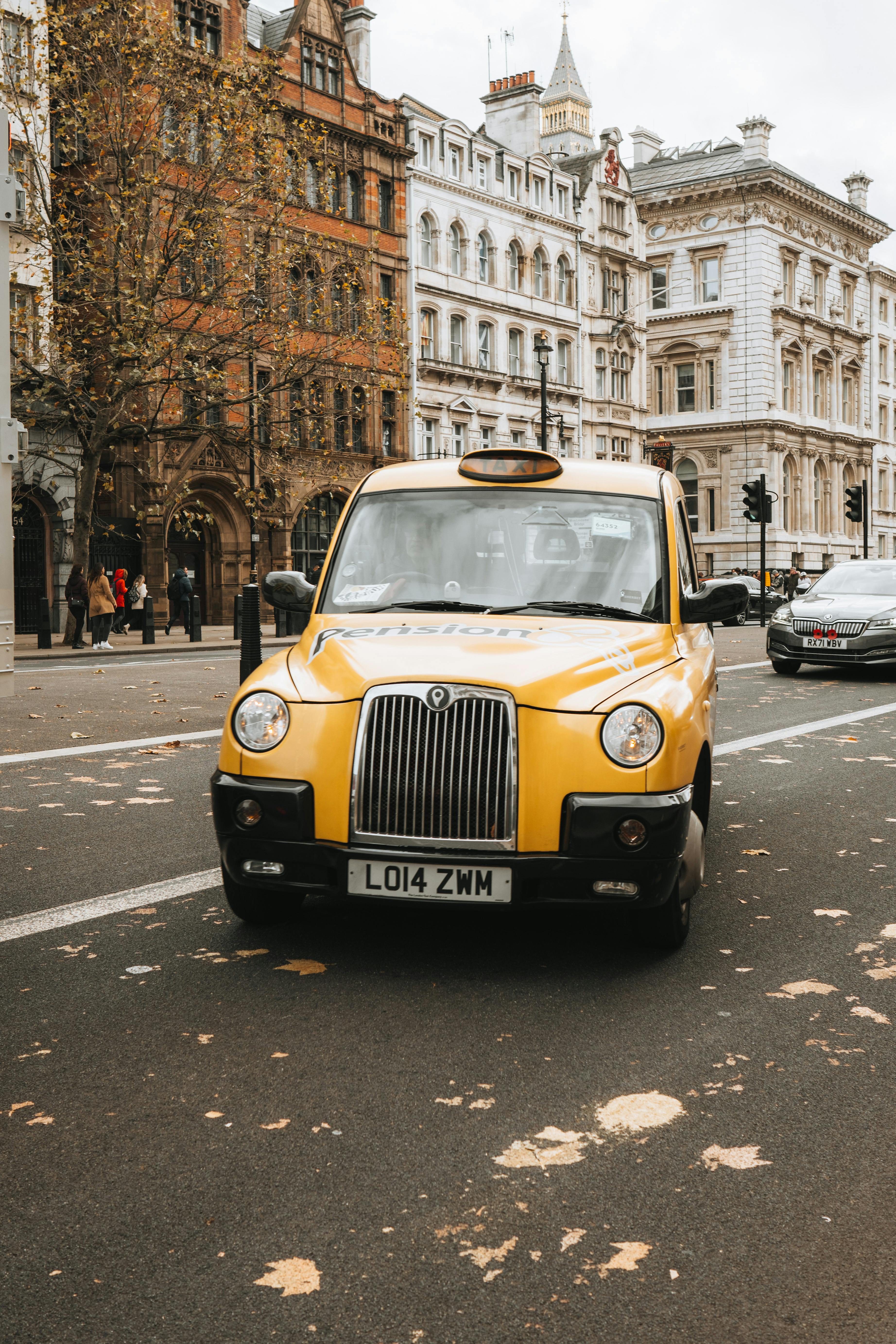 Yellow TX4 Taxi in London · Free Stock Photo