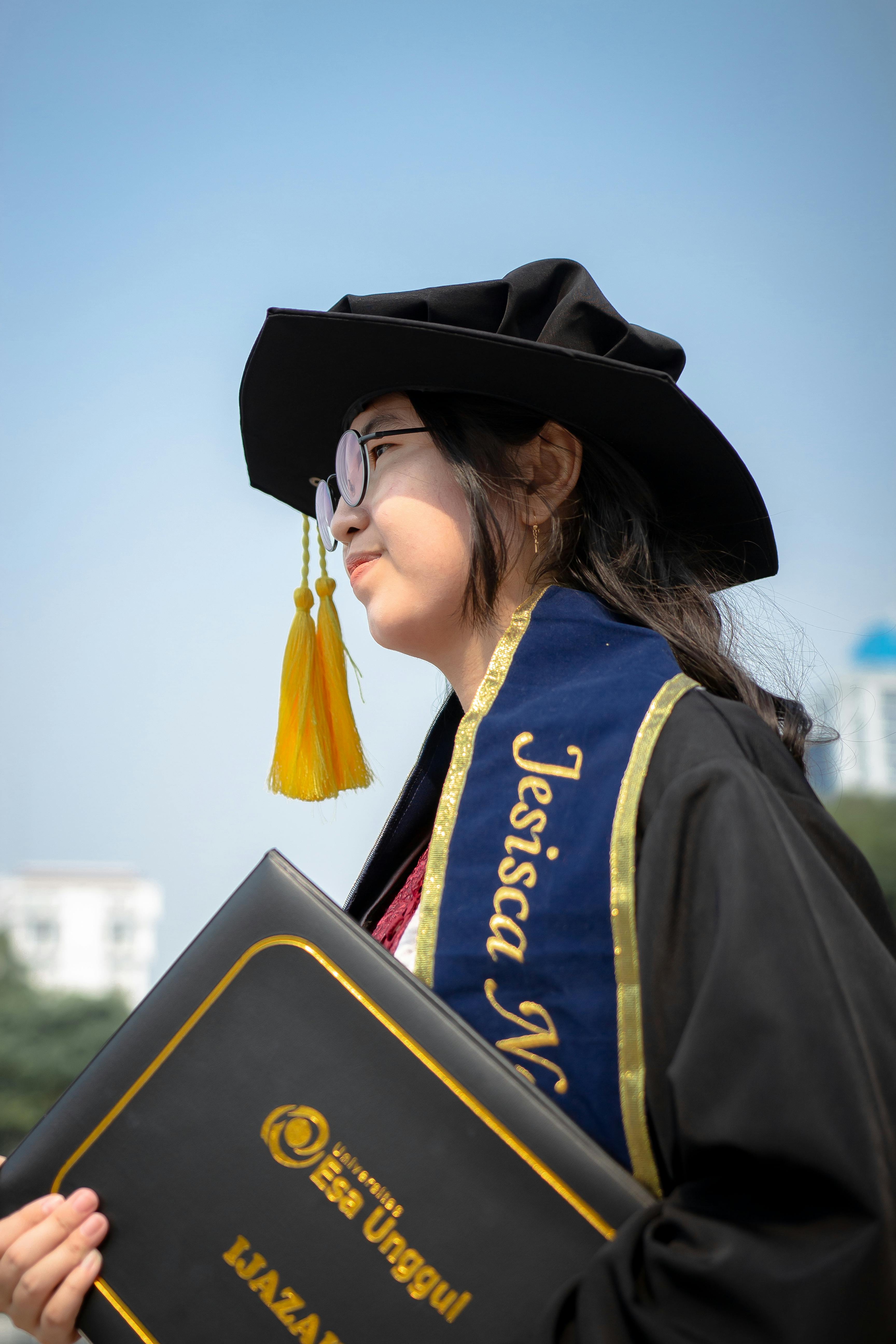 Women Wearing Academic Dress Holding Diplomas · Free Stock Photo