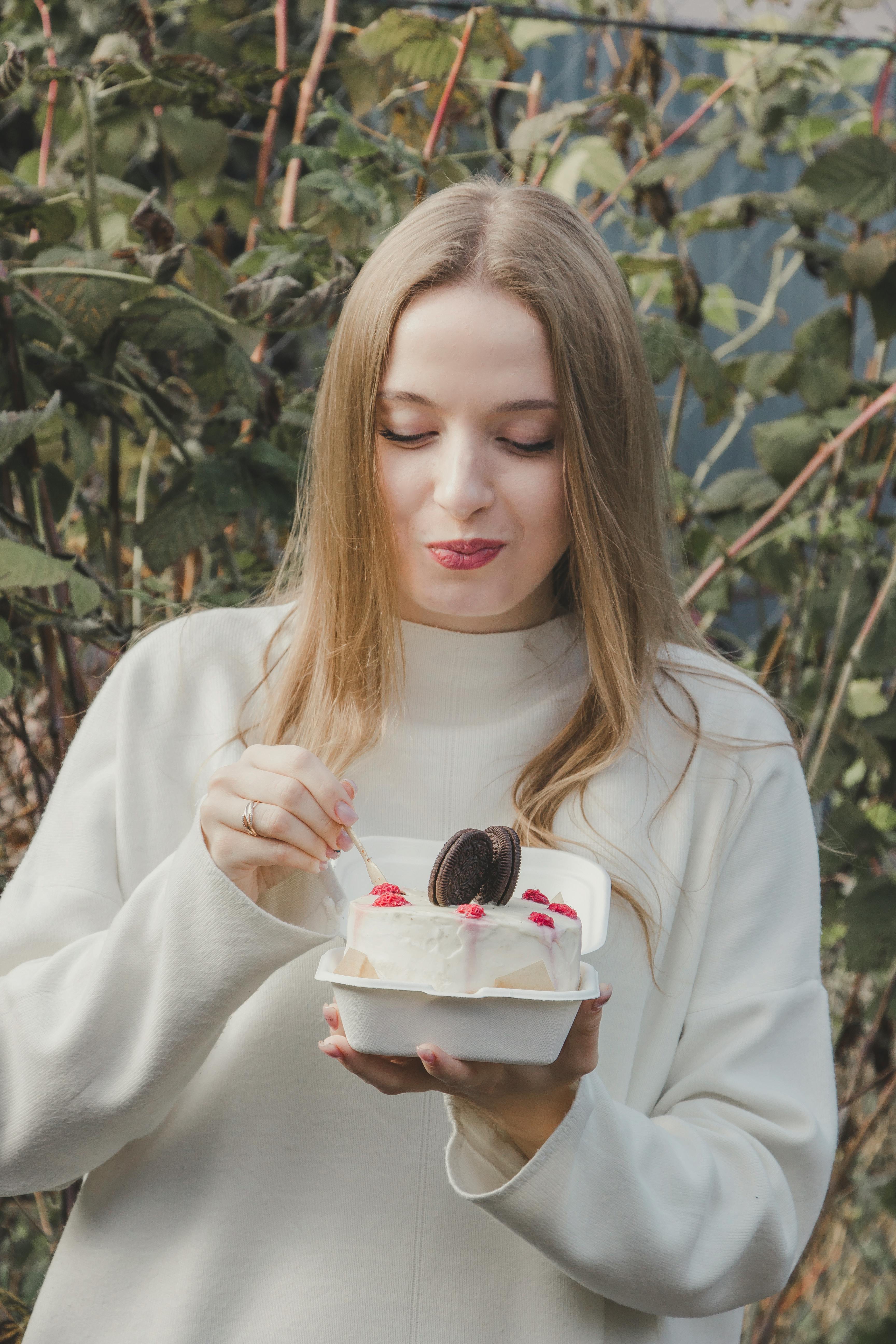 Smiling Woman Eating Cake · Free Stock Photo