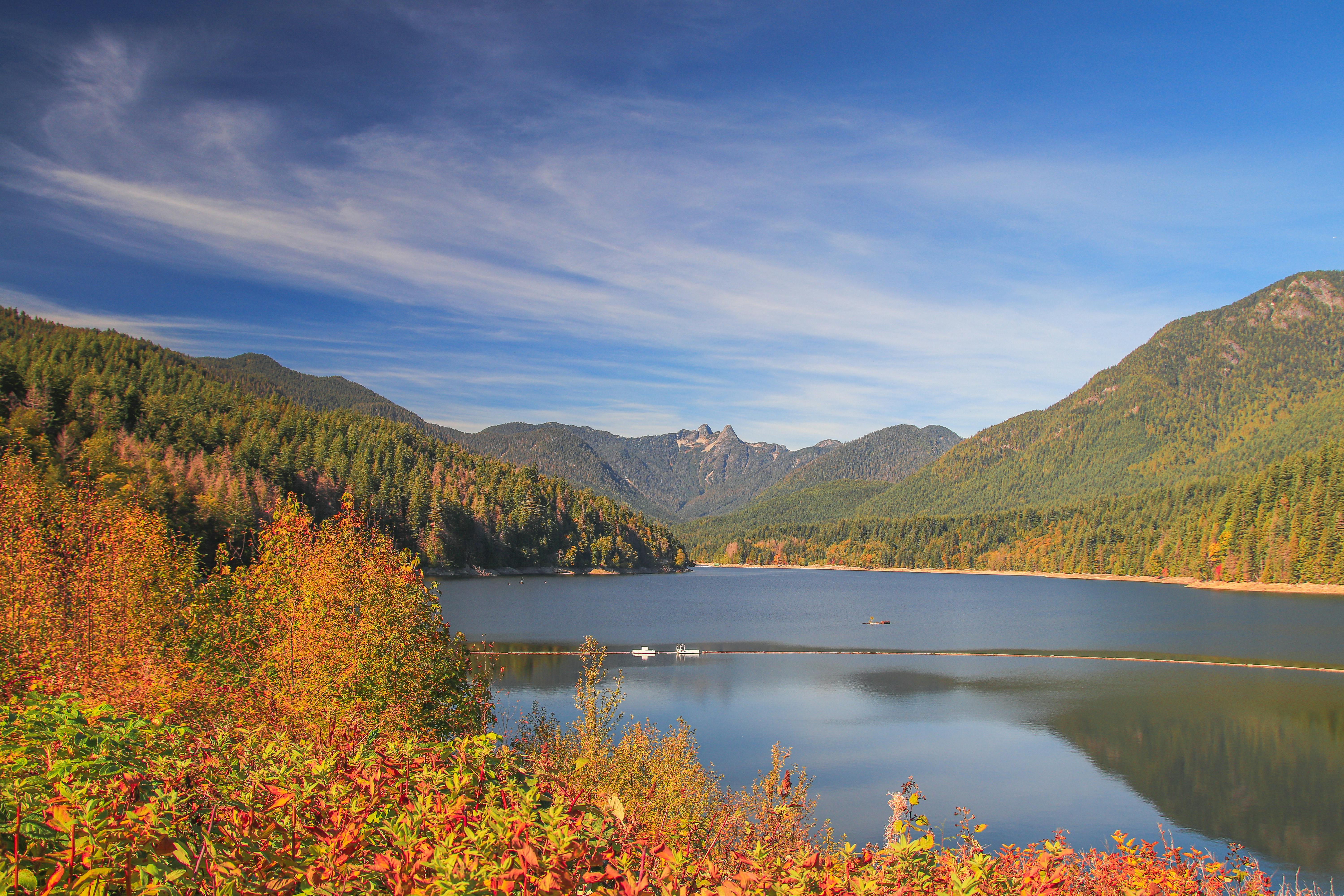 Capilano Lake in Mountains Surrounded by Autumn Forest · Free Stock Photo