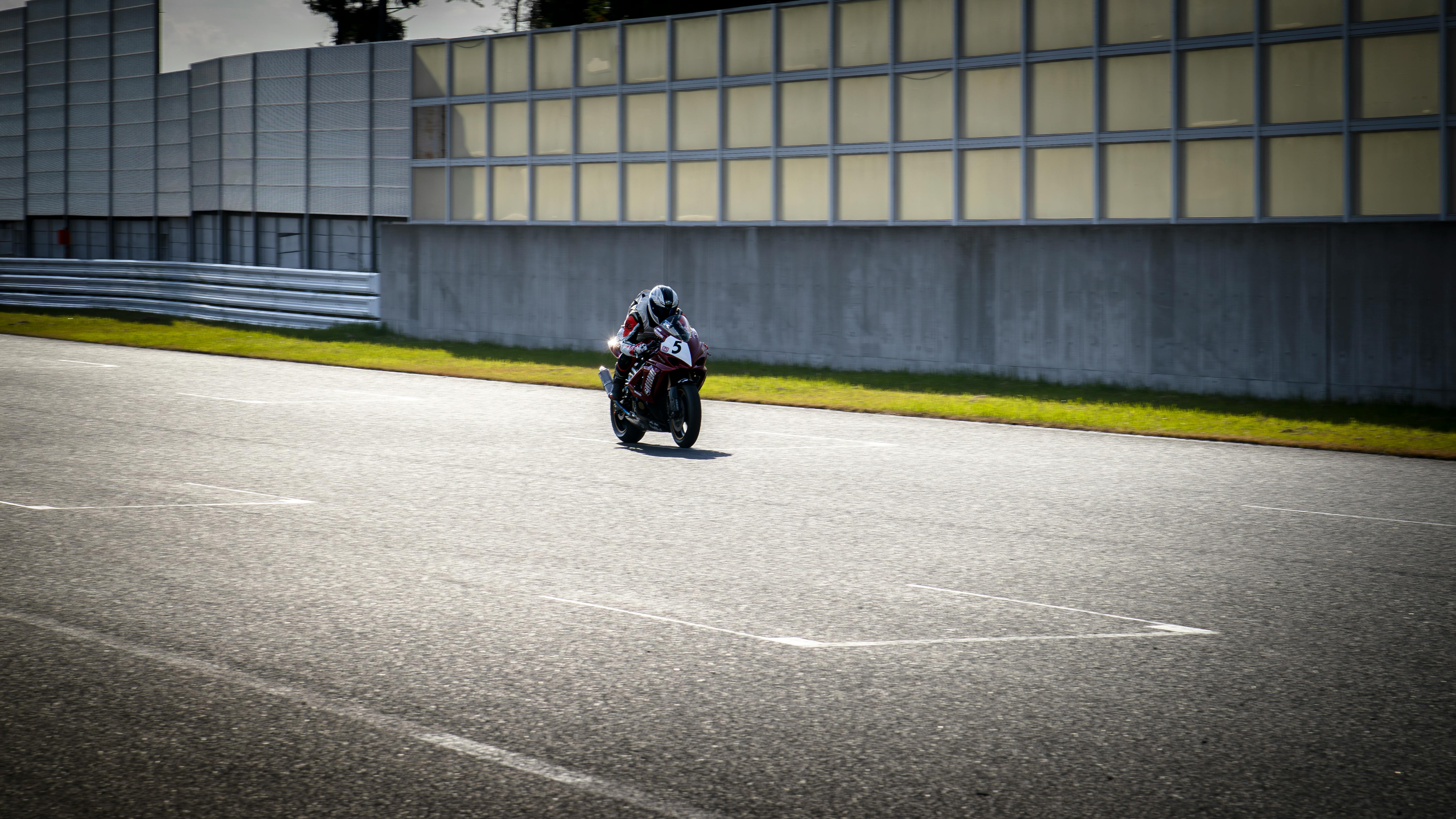 Person Riding a Motorcyle on a Racetrack · Free Stock Photo