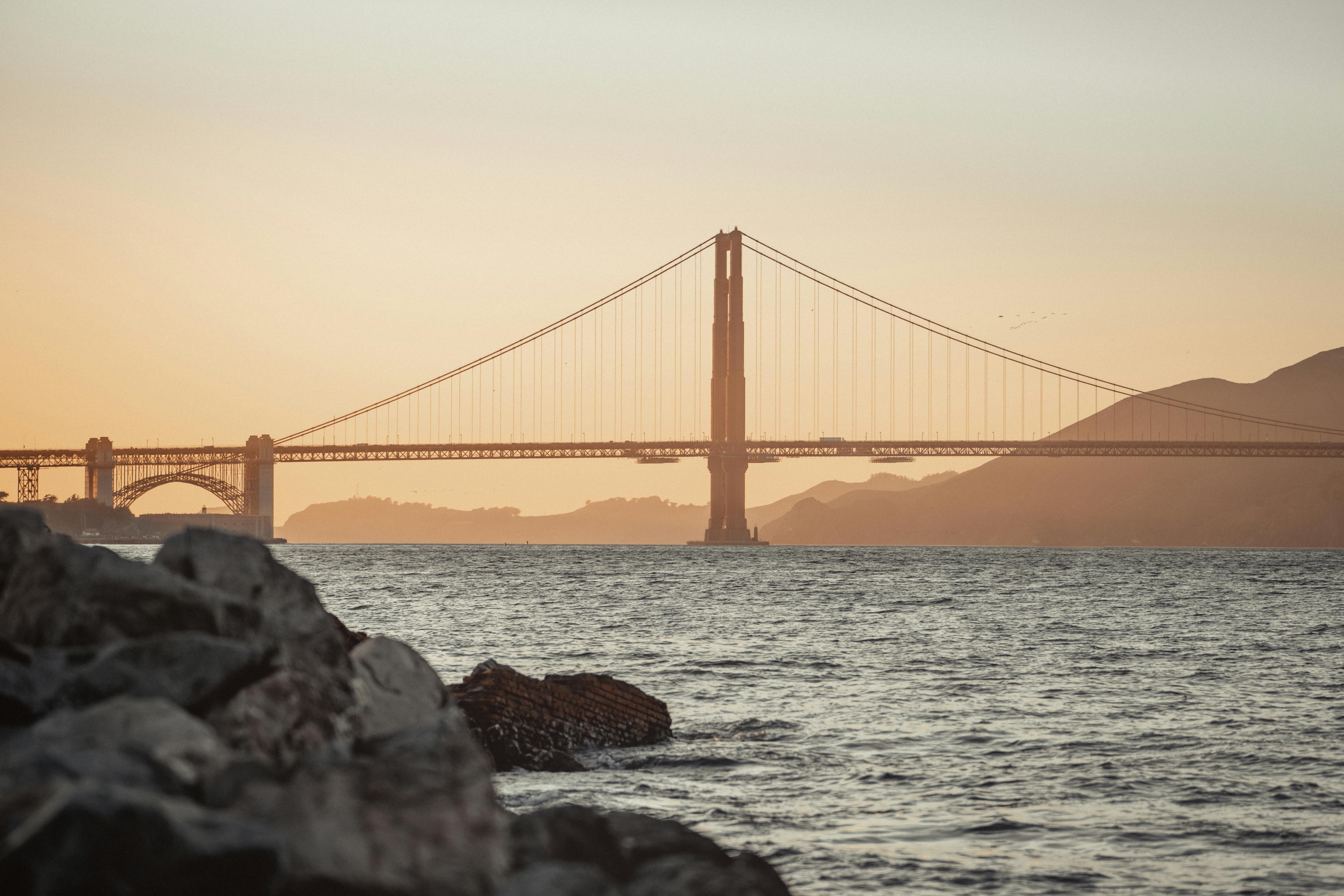 Woman Wearing Brown Topcoat Standing in Front of Golden Gate Bridge ...