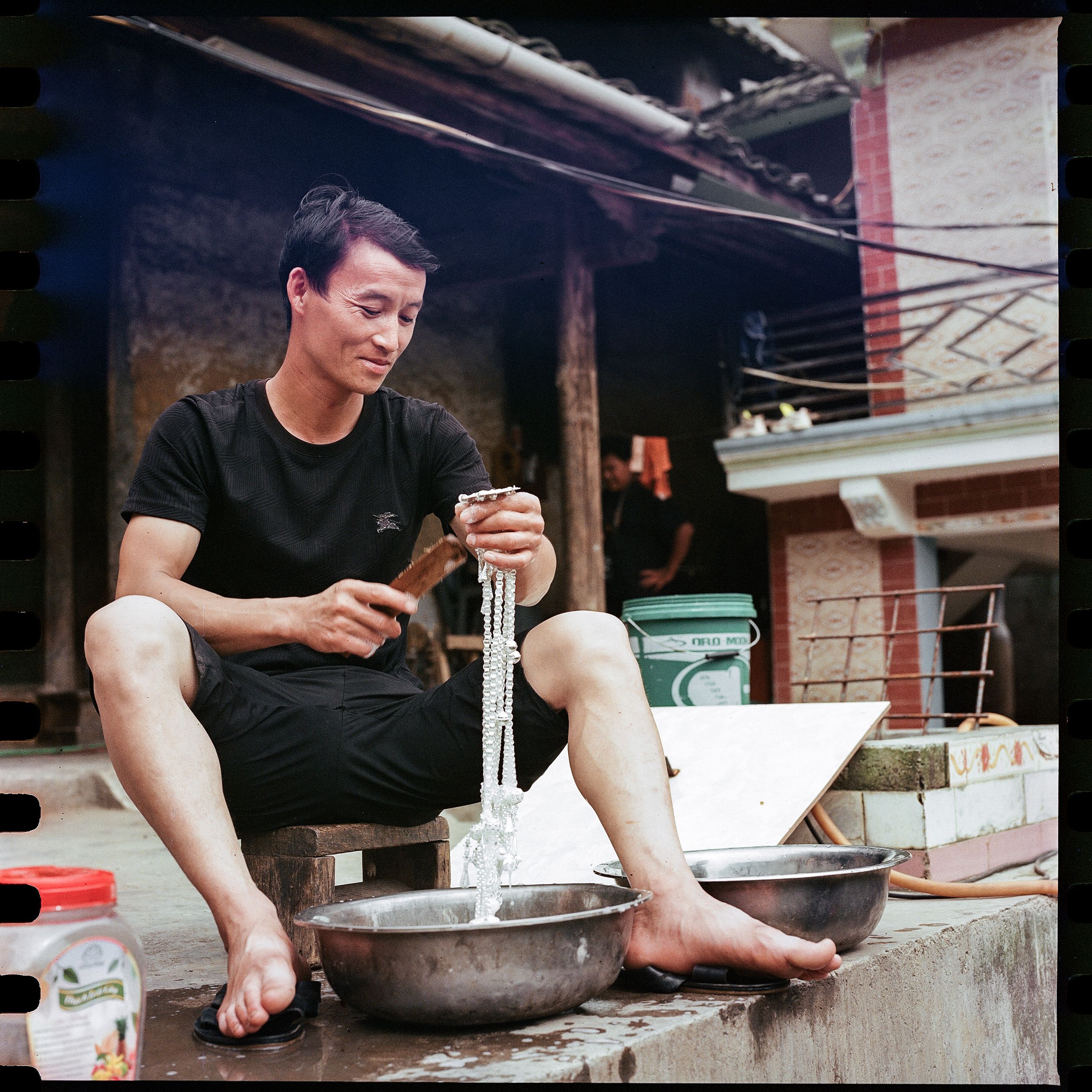 Man Sitting on the Sidewalk with a String of Beads in his Hands · Free ...
