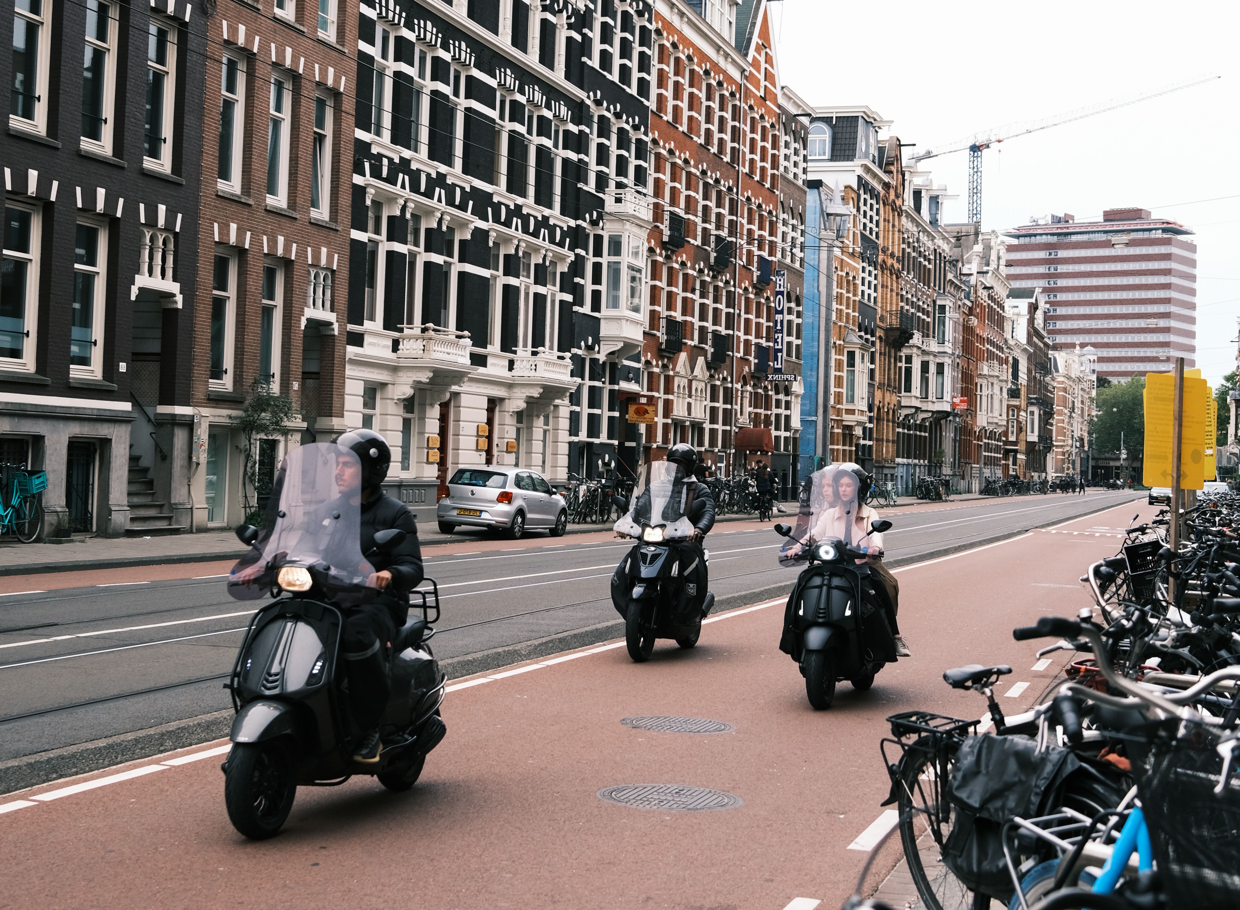 Mopeds Driving Down Busy Amsterdam Street · Free Stock Photo