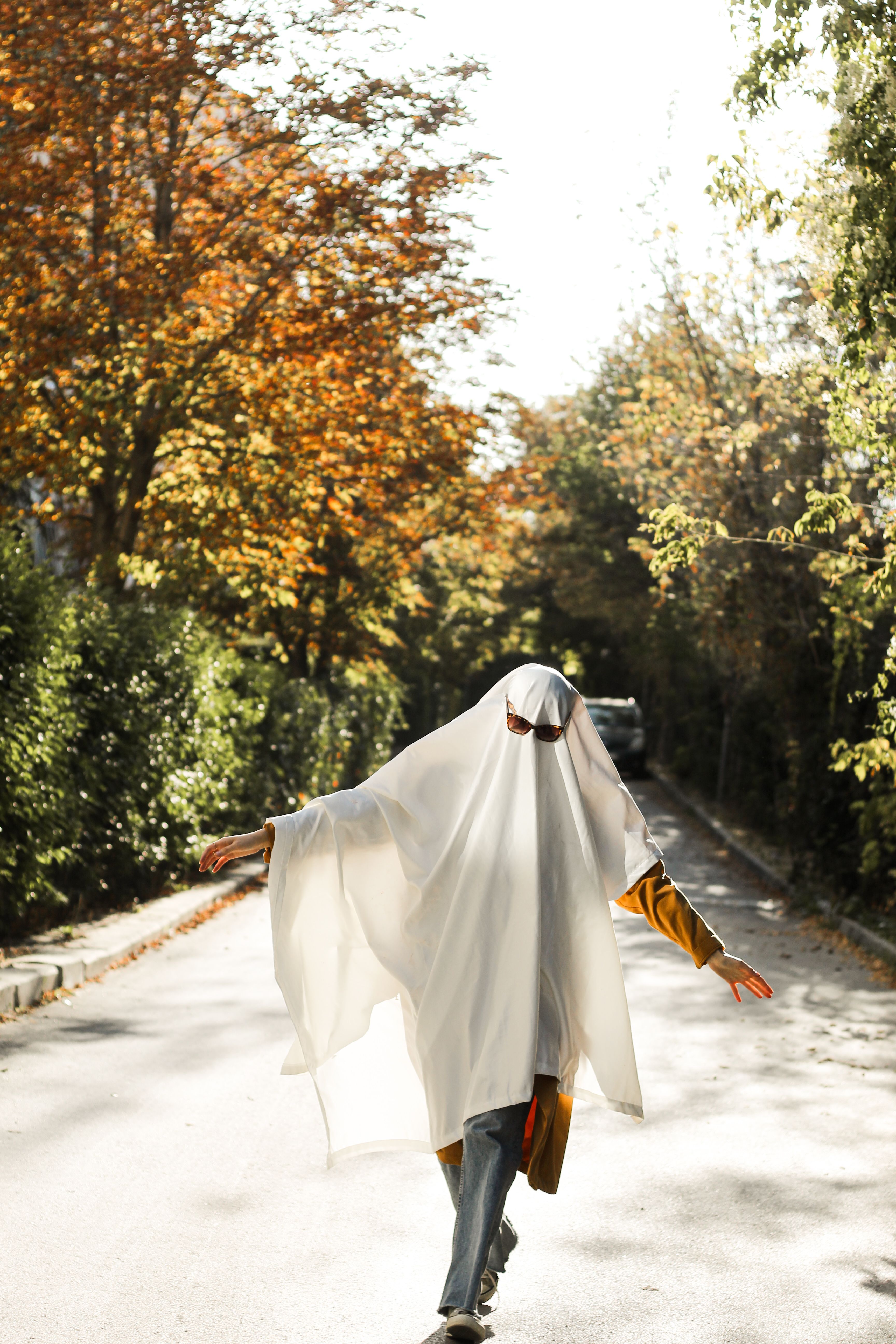 Person Dressed as a Ghost Running in a Park · Free Stock Photo