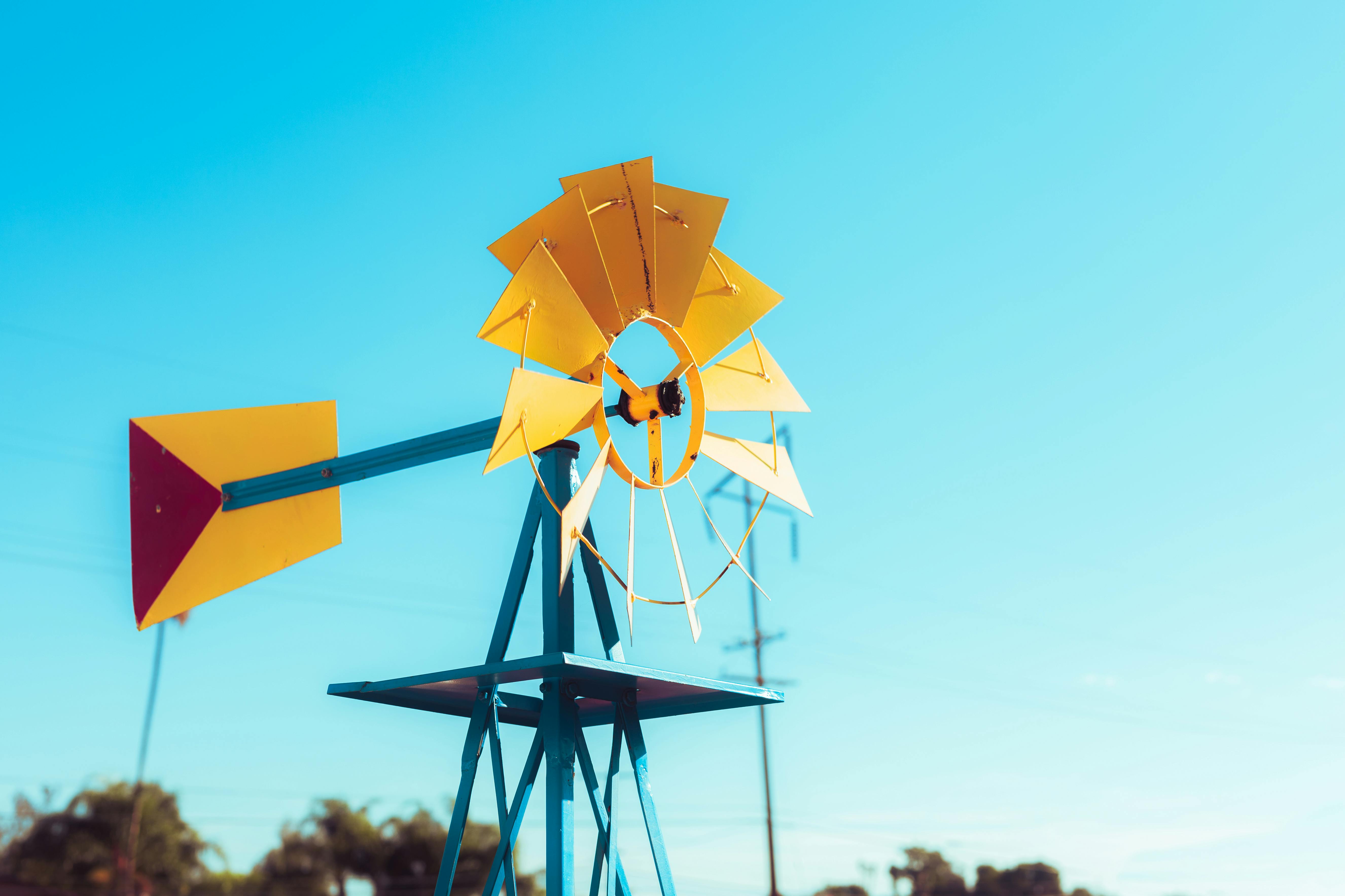 Close-up of a Yellow Metal Windmill against Blue Sky · Free Stock Photo