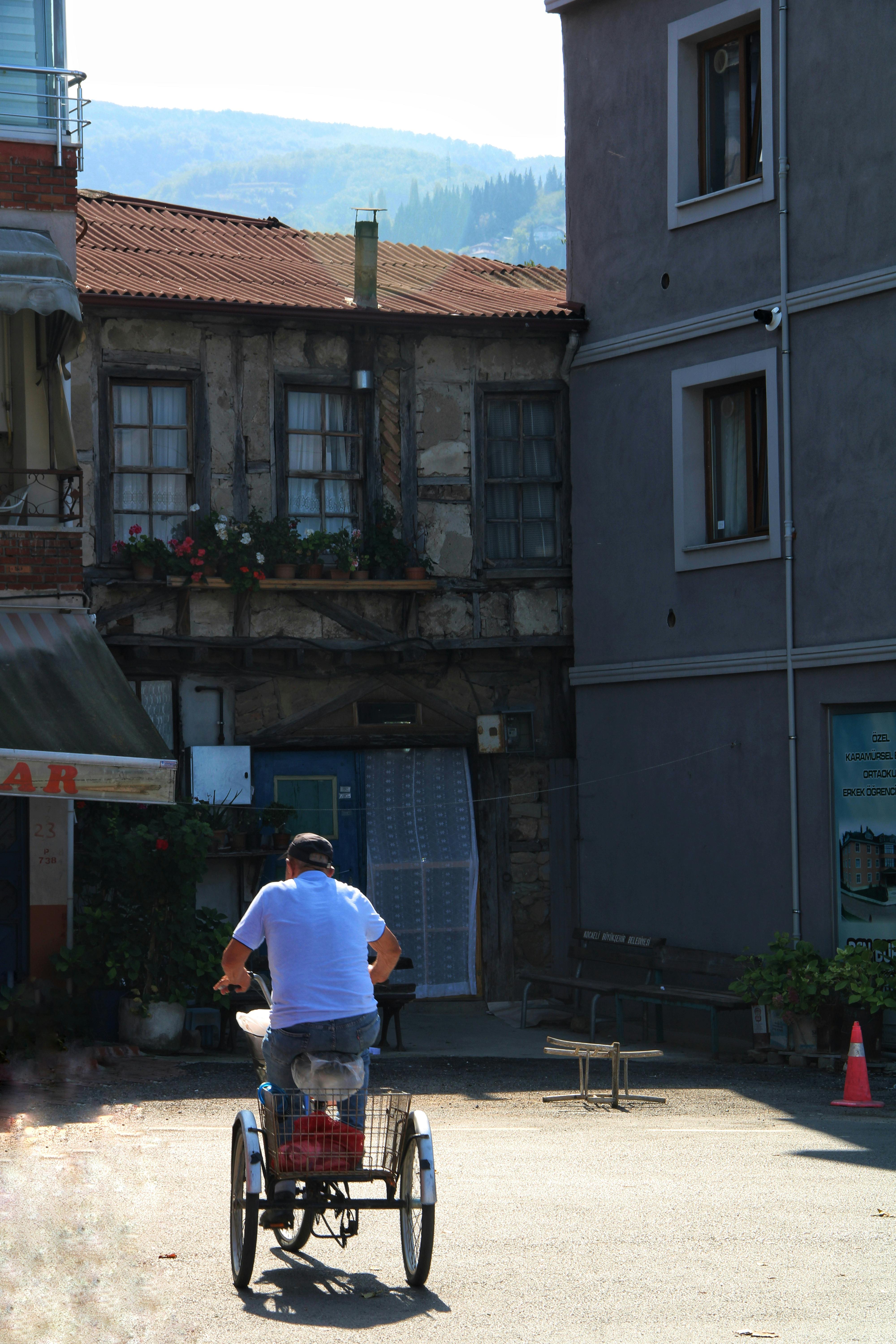 Man Riding a Tricycle · Free Stock Photo