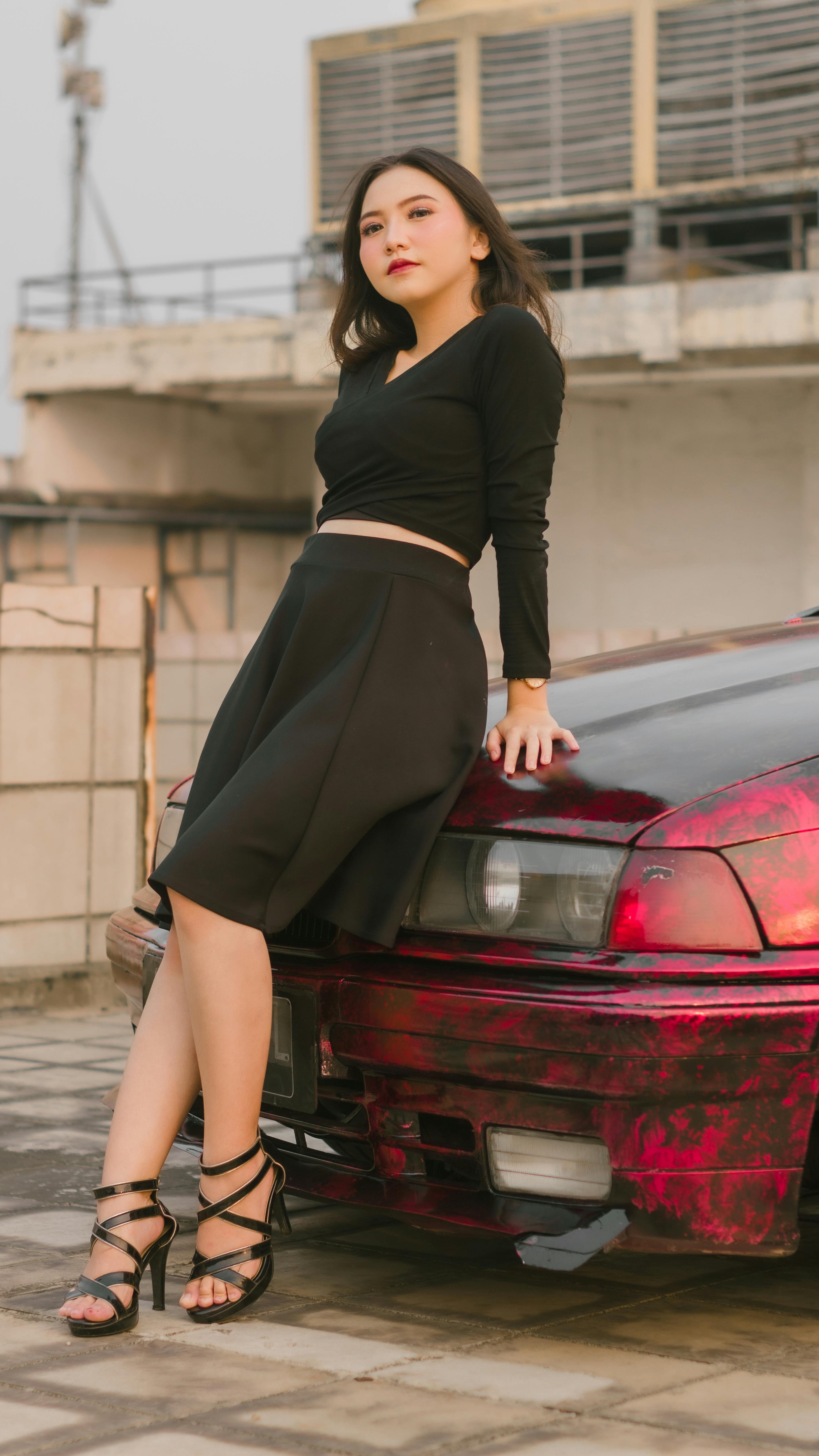 Young Elegant Woman Leaning against a Car · Free Stock Photo