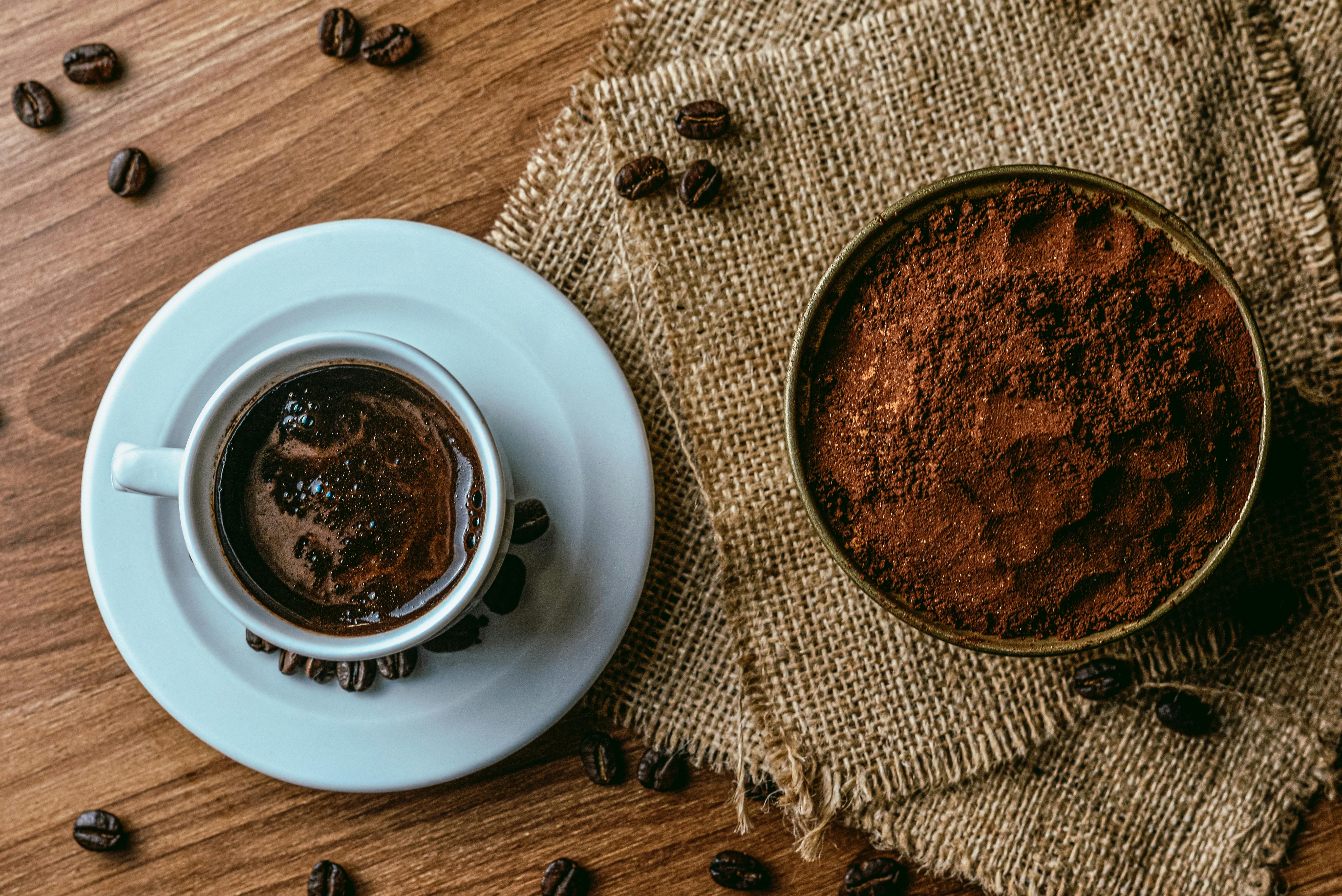 Cup of Coffee With Roasted Beans and Ground Coffee on Wooden Table ...