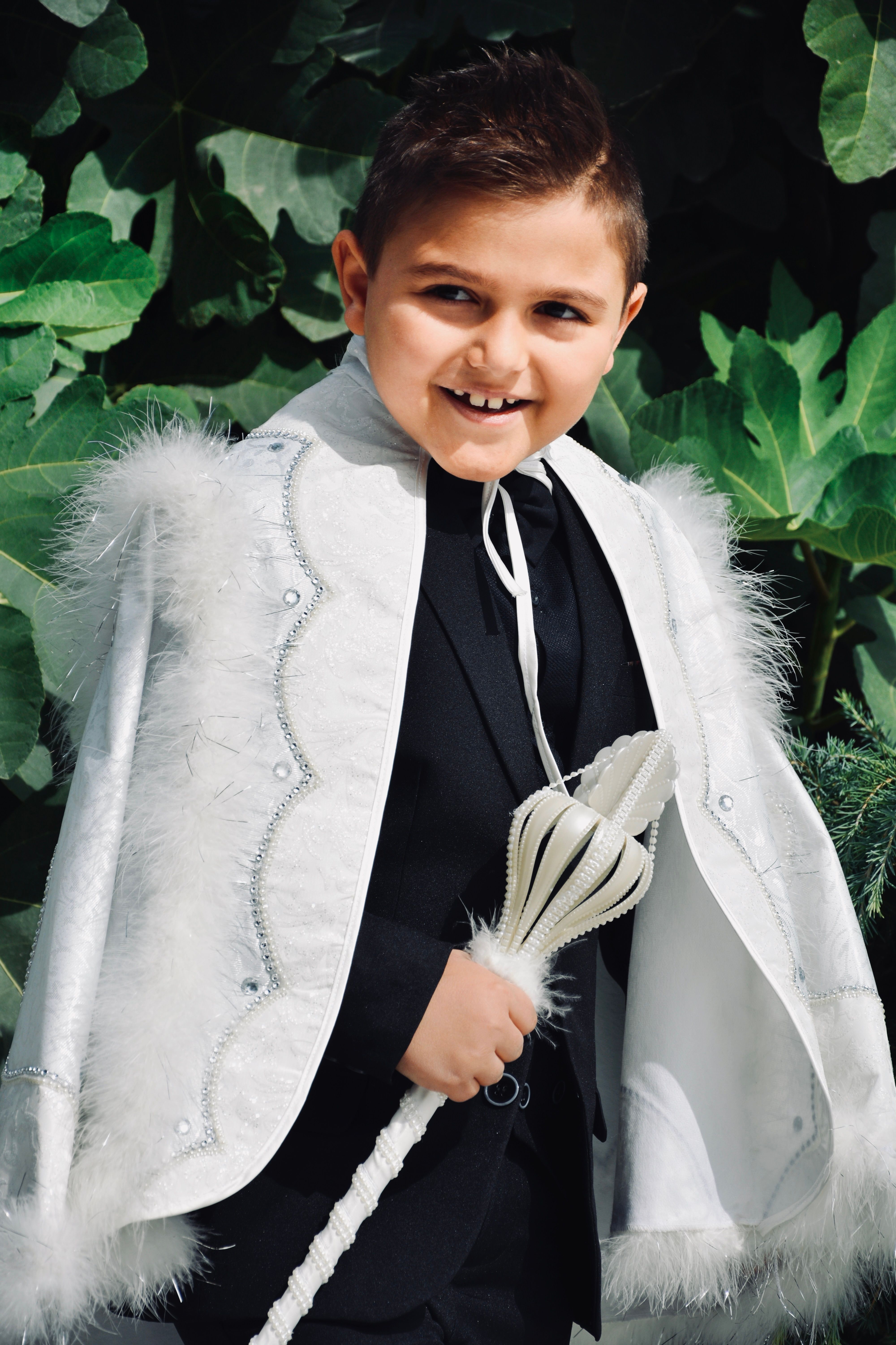 Happy little Asian boy in magician costume doing trick · Free Stock Photo