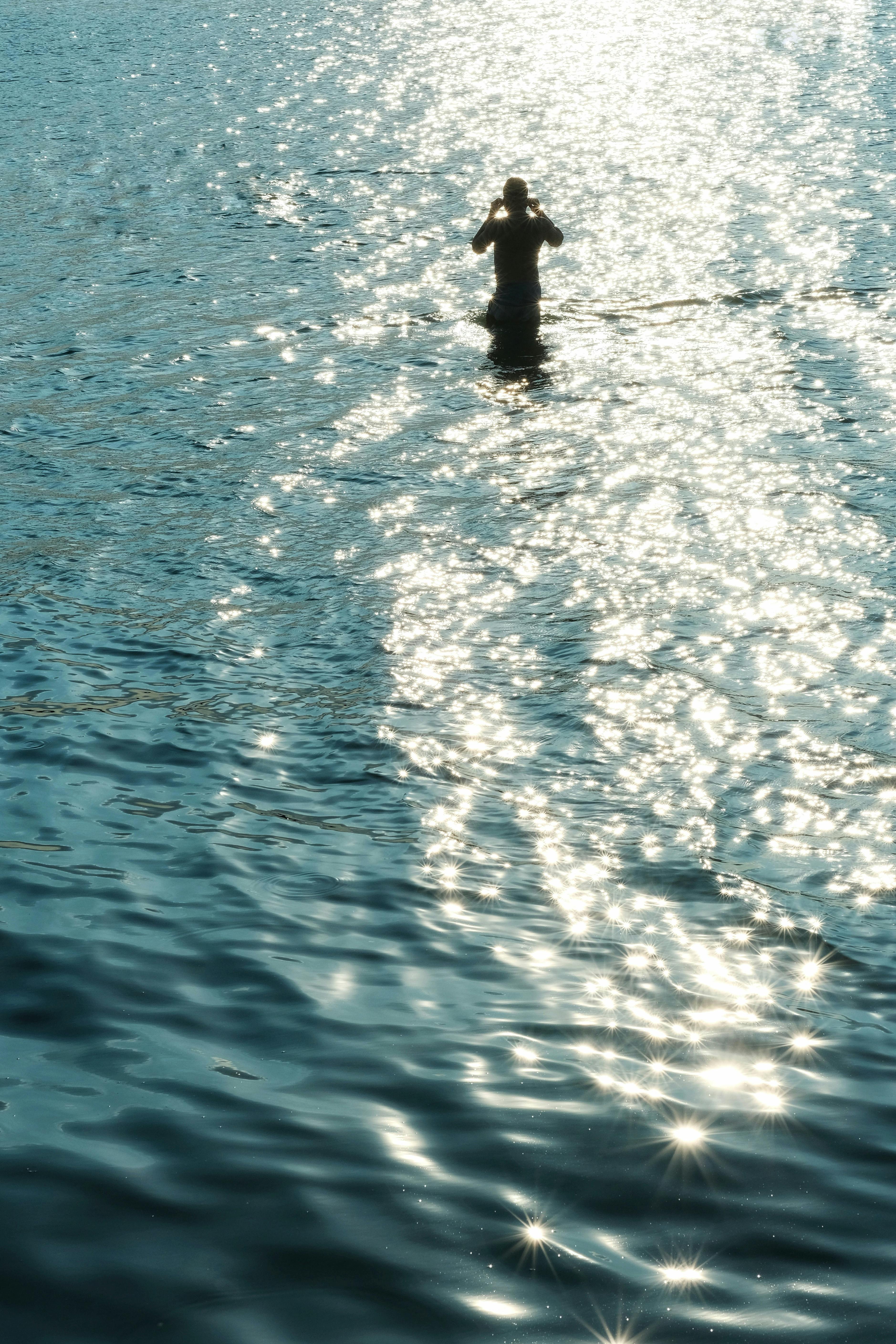 Silhouette of Person Standing in Water · Free Stock Photo