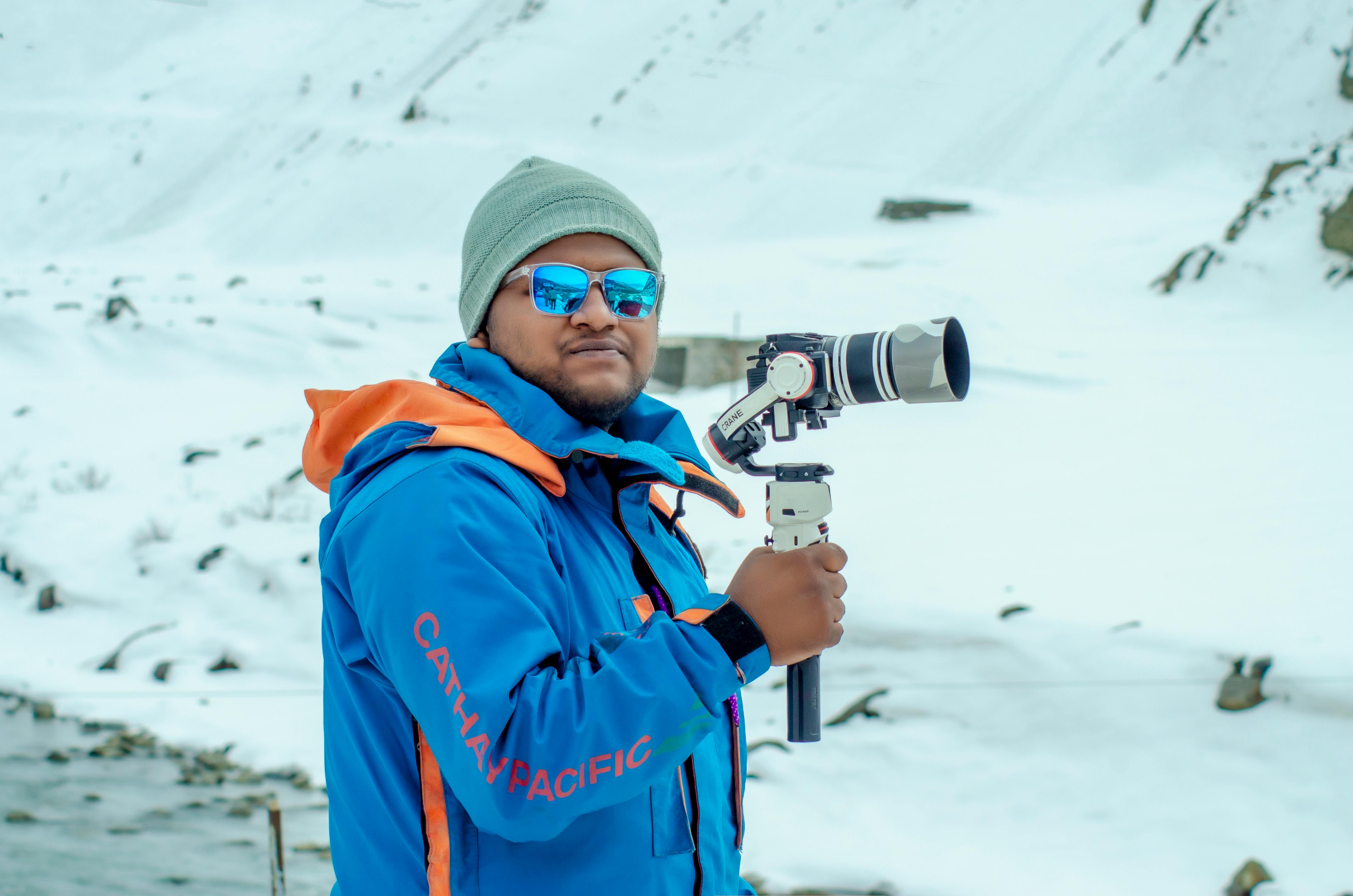 Photographer Filming with a Camera on Gimbal in Winter Mountains · Free ...