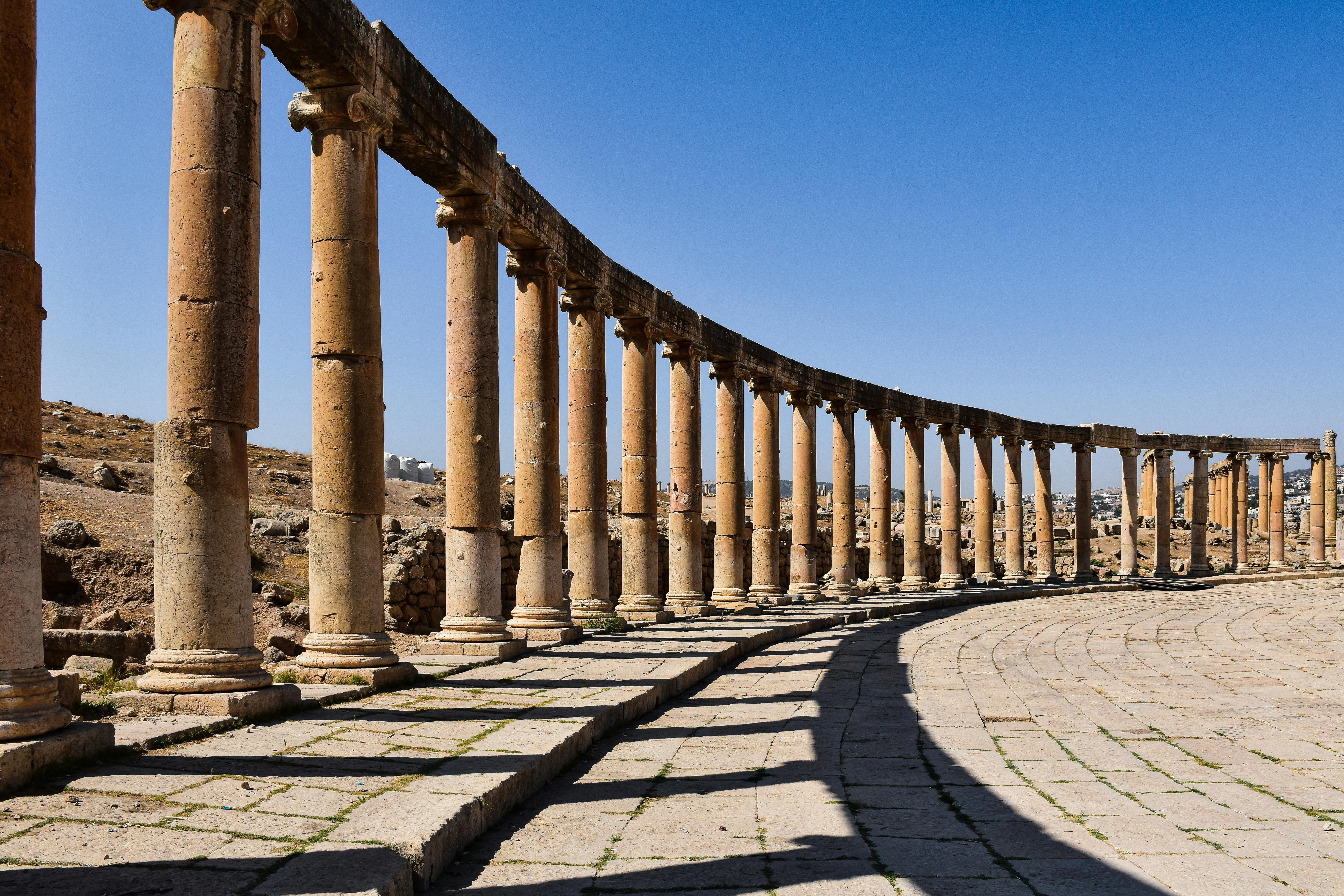 Man Walking in Colonnaded Street · Free Stock Photo