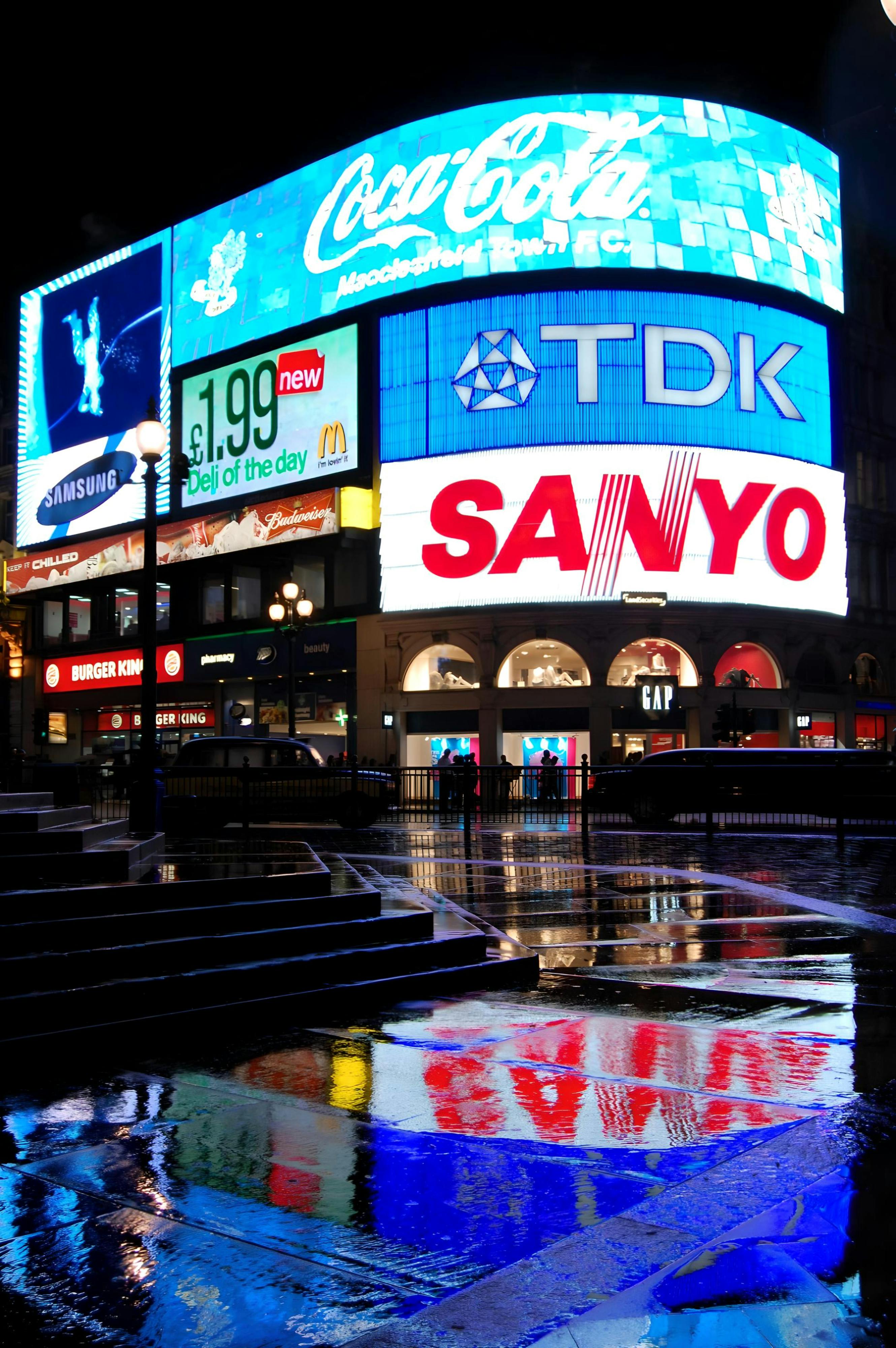 Neon Billboards Reflecting in the Wet Pavement on Piccadilly Circus ...