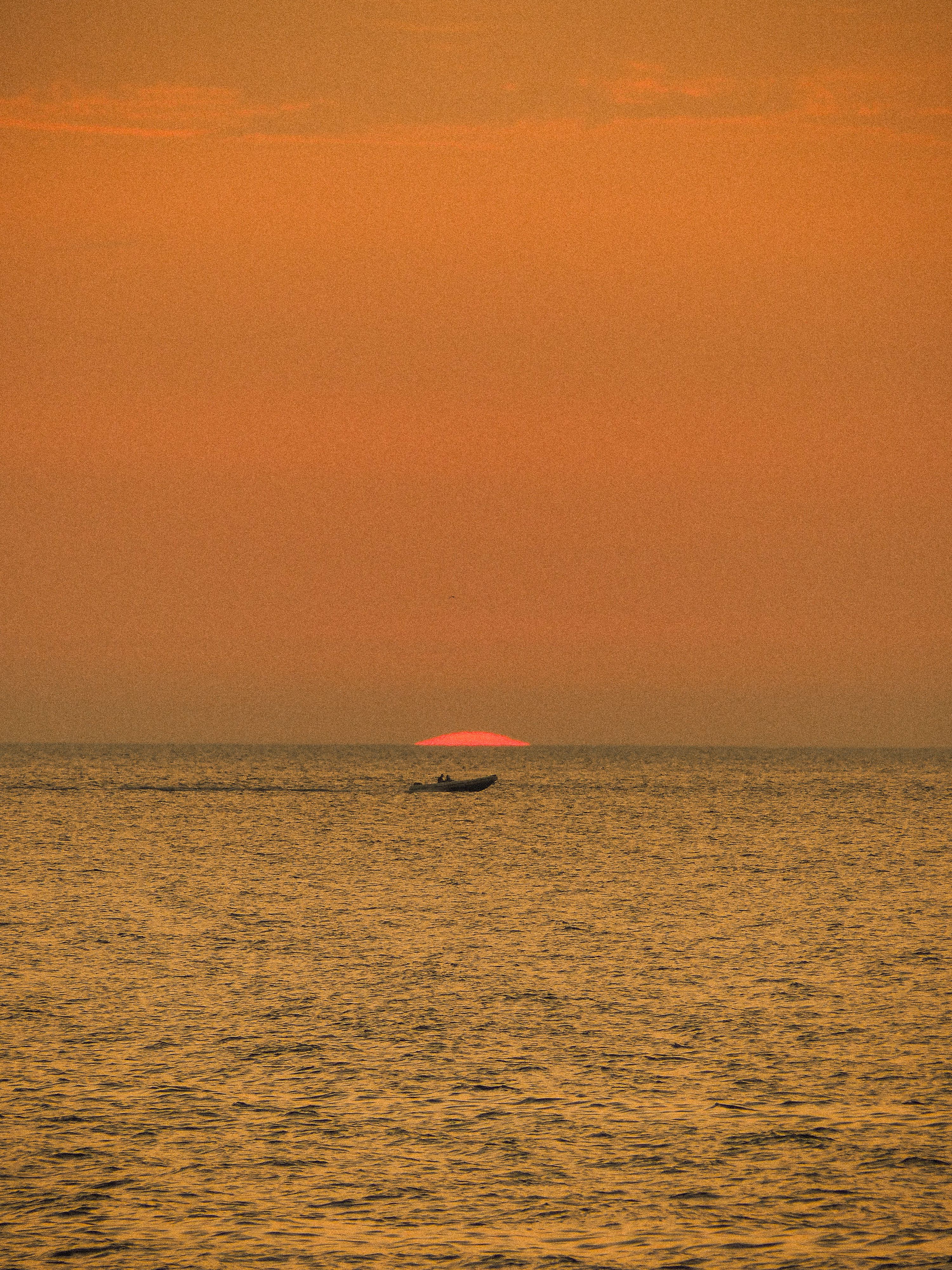 Silhouette of Person on Body of Water during Sunset · Free Stock Photo