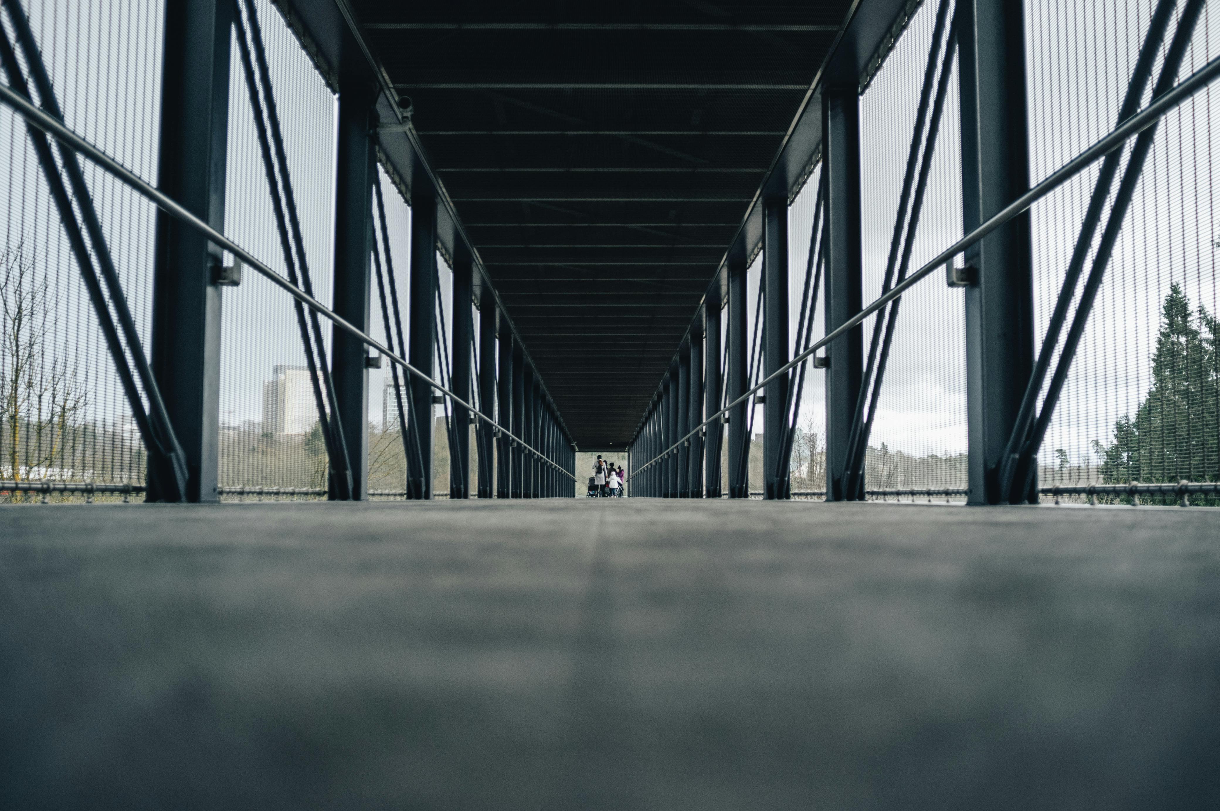 People Walking down the Elevated Footbridge · Free Stock Photo
