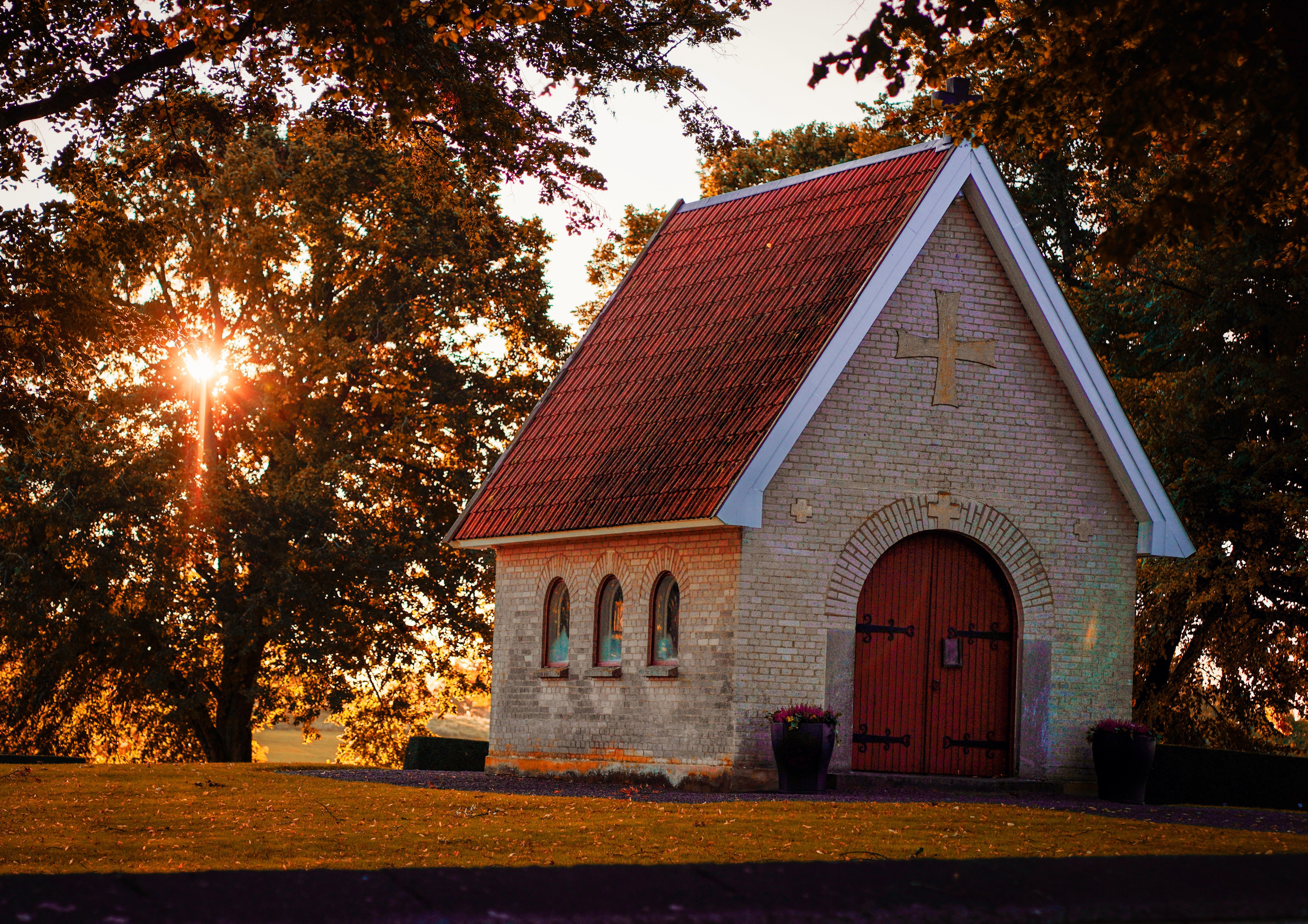 Sunset Sunlight over Vintage Chapel Building among Trees · Free Stock Photo
