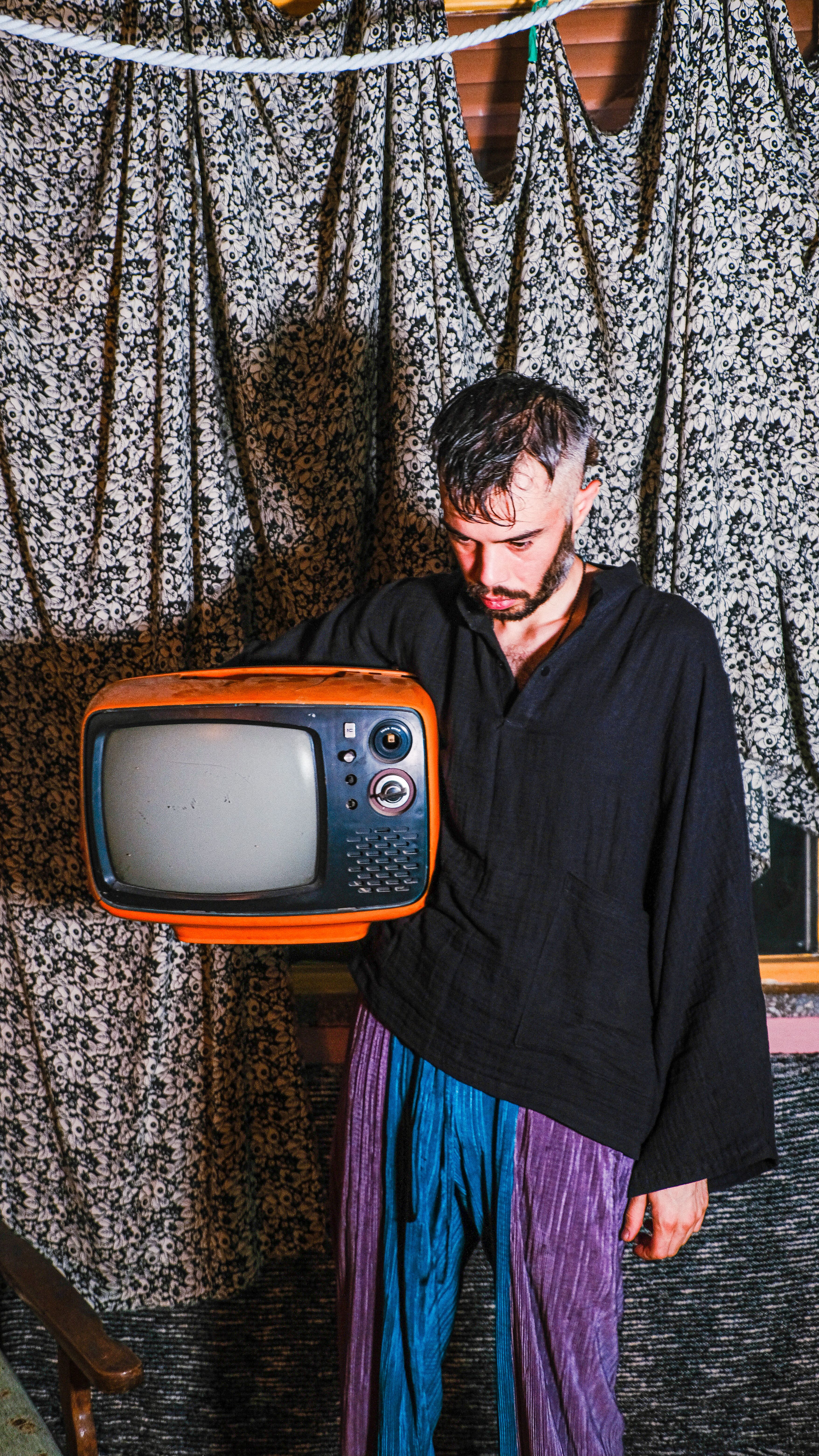 Man Standing with Vintage TV · Free Stock Photo