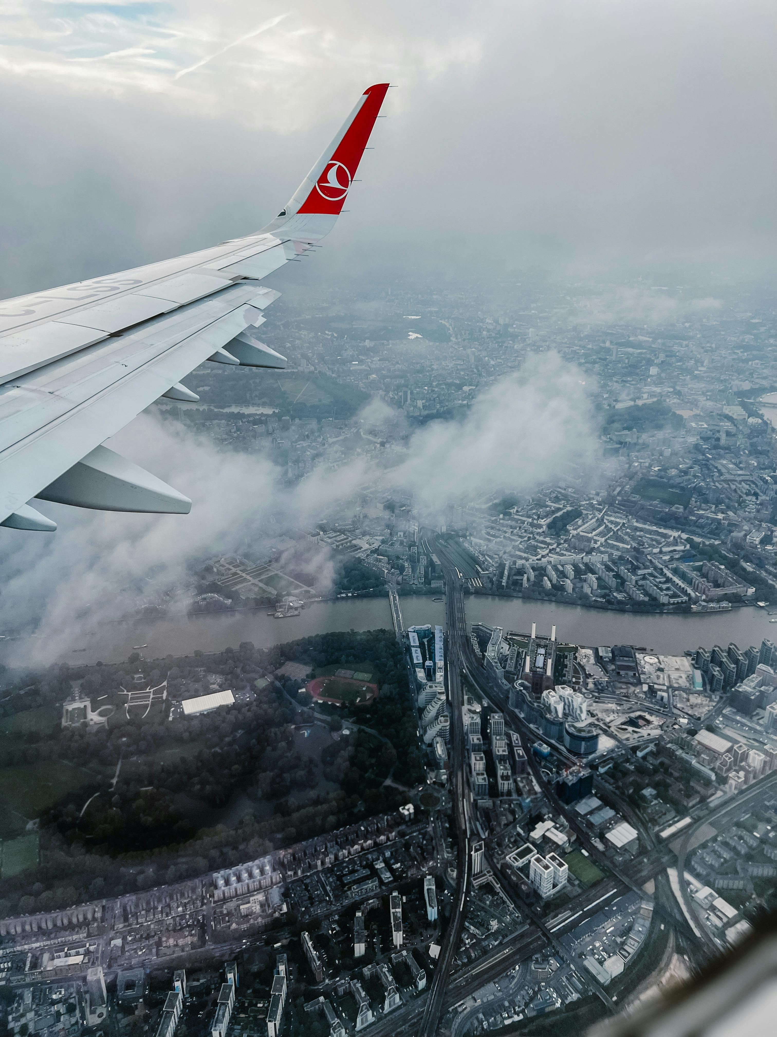 View From Passenger Jet Window while Flying Low Over a City · Free ...
