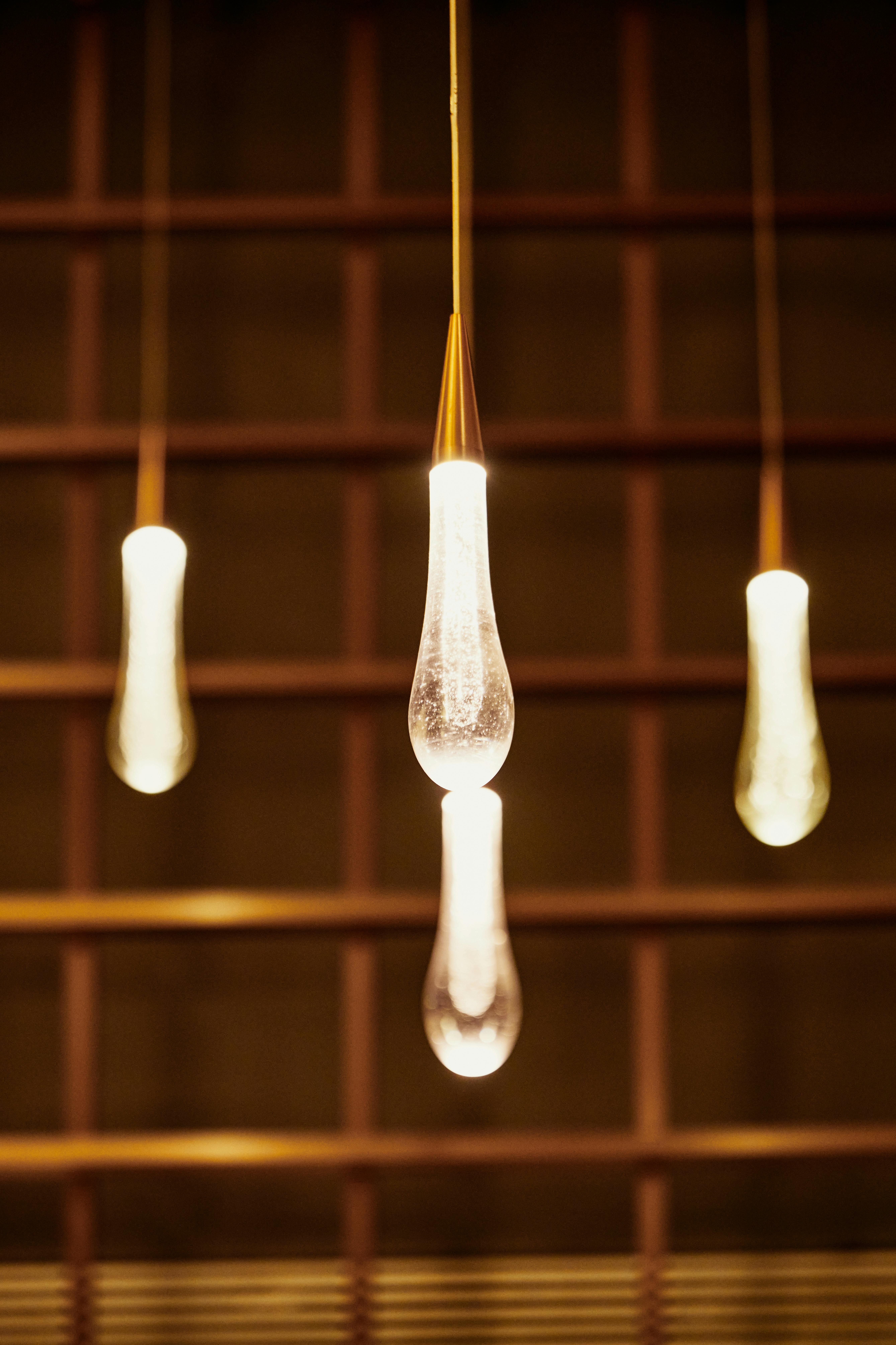 Four Hanging Light Bulbs Beside Chair · Free Stock Photo