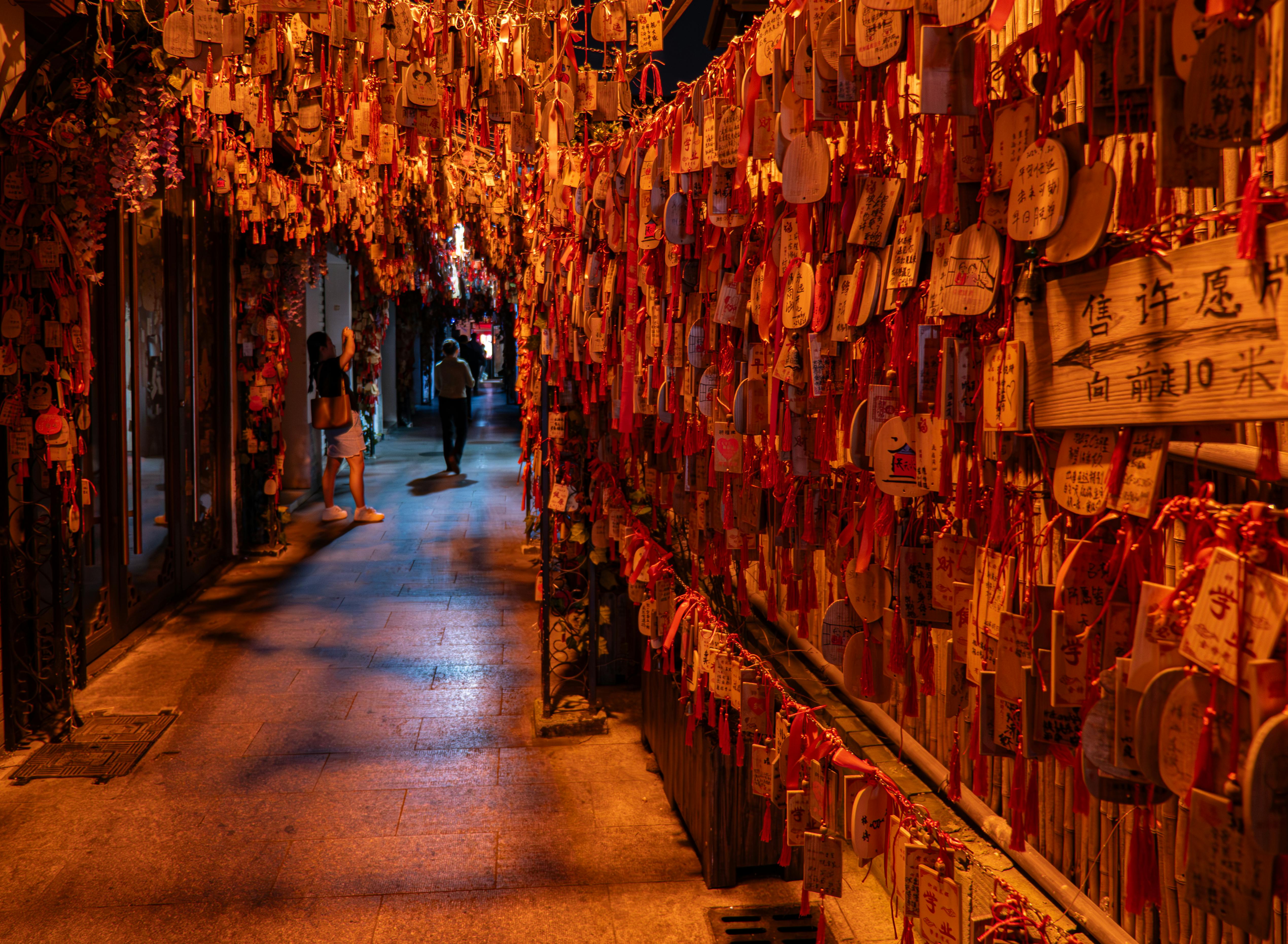 Decorations Hanging on Wall and over Alley in Town · Free Stock Photo