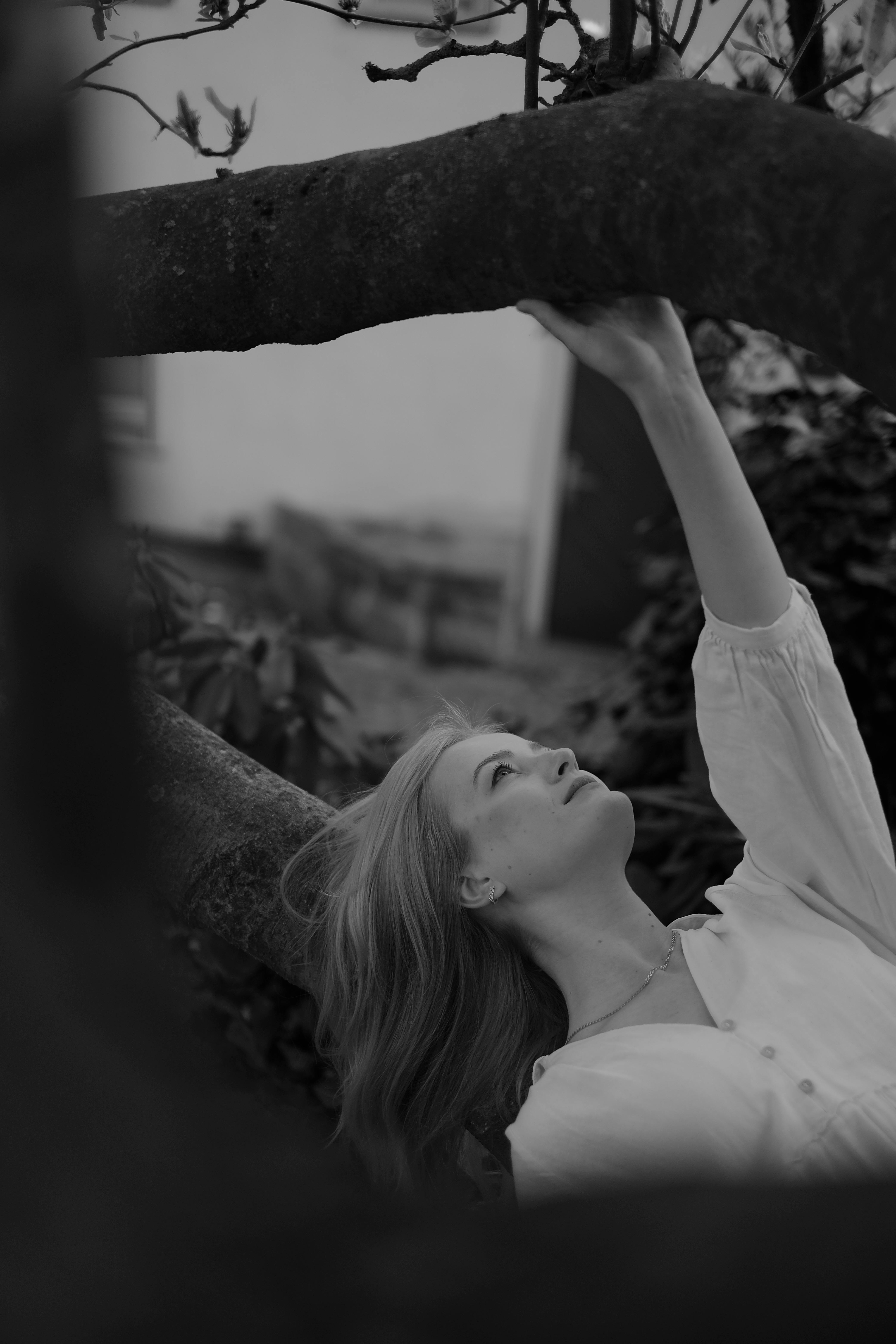 Woman Leaning on Tree Branches in Black and White · Free Stock Photo