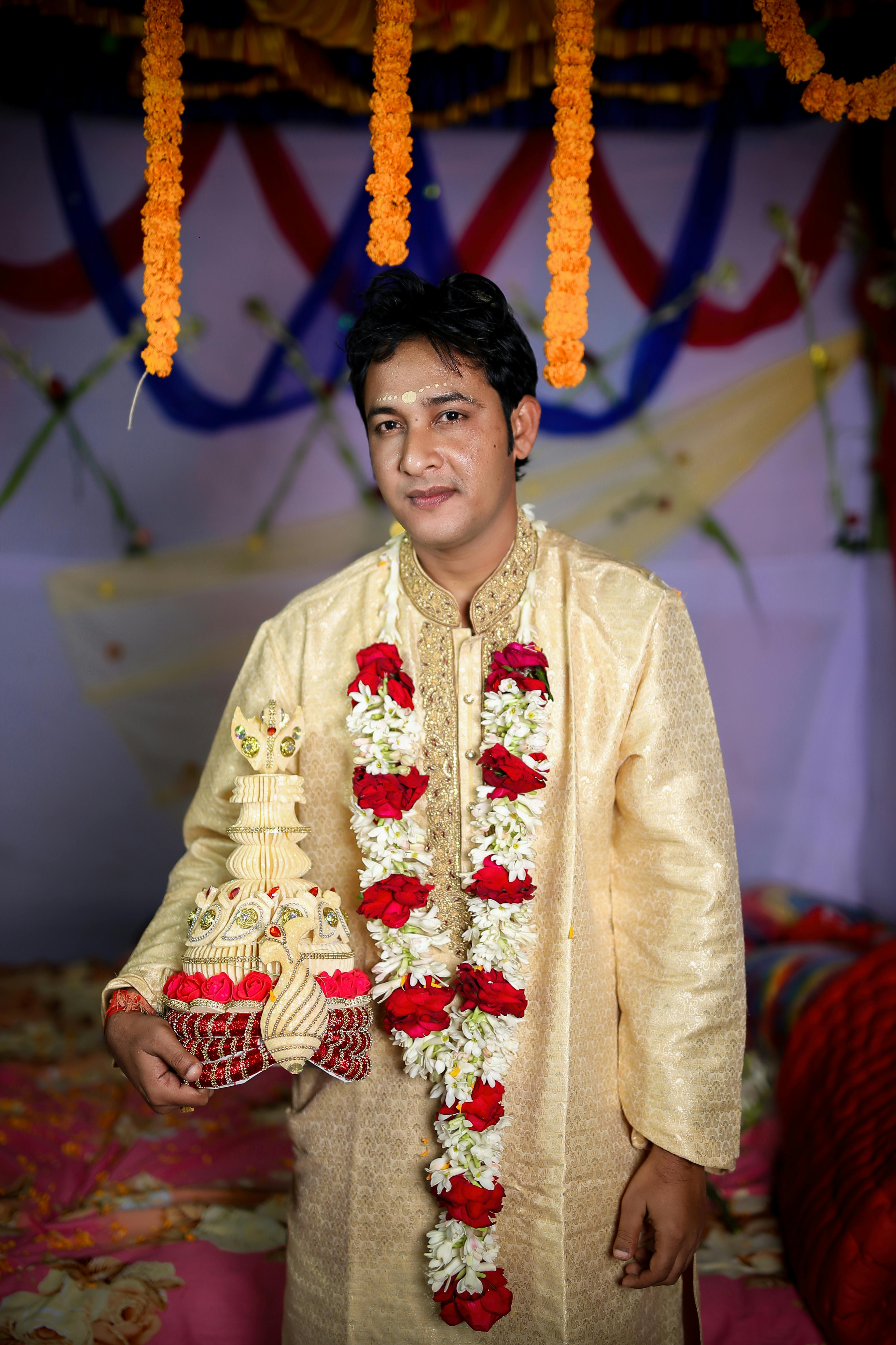 Bridegroom in a Golden Kurta and Varamala Garland Holding Traditional ...