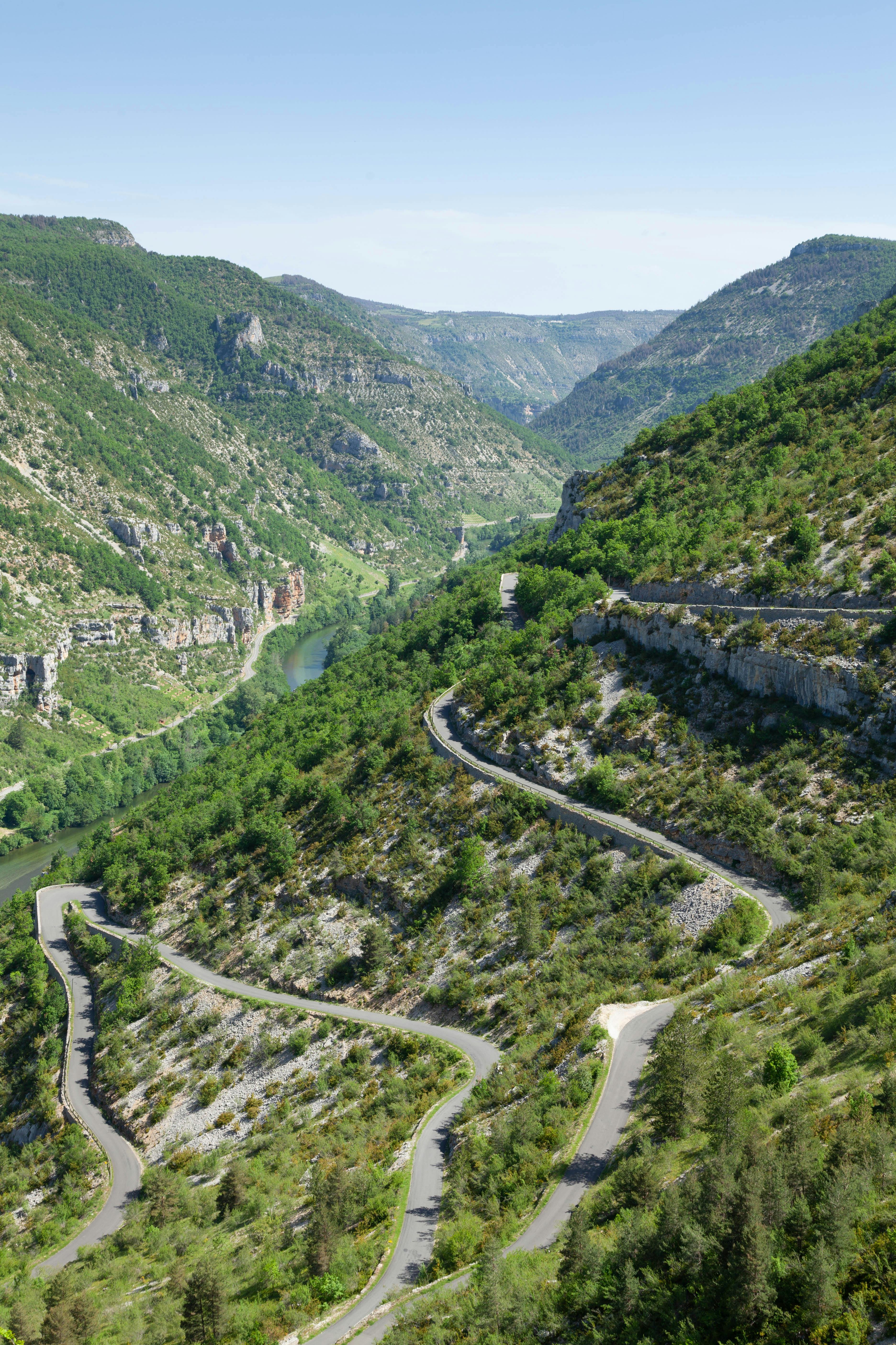 Winding Road Descending Downhill to River Valley · Free Stock Photo