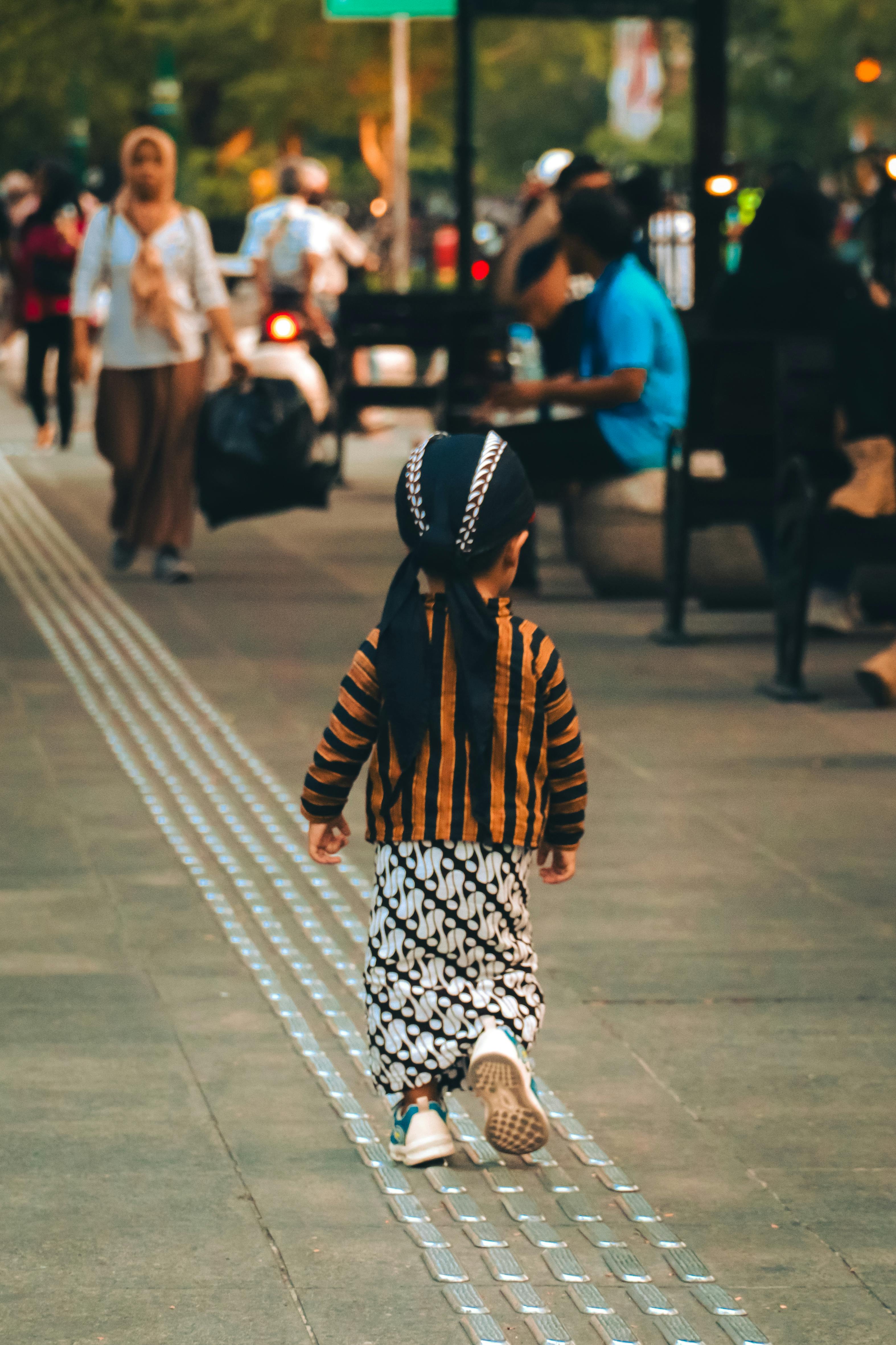 Child in Buff Walking on Pavement · Free Stock Photo