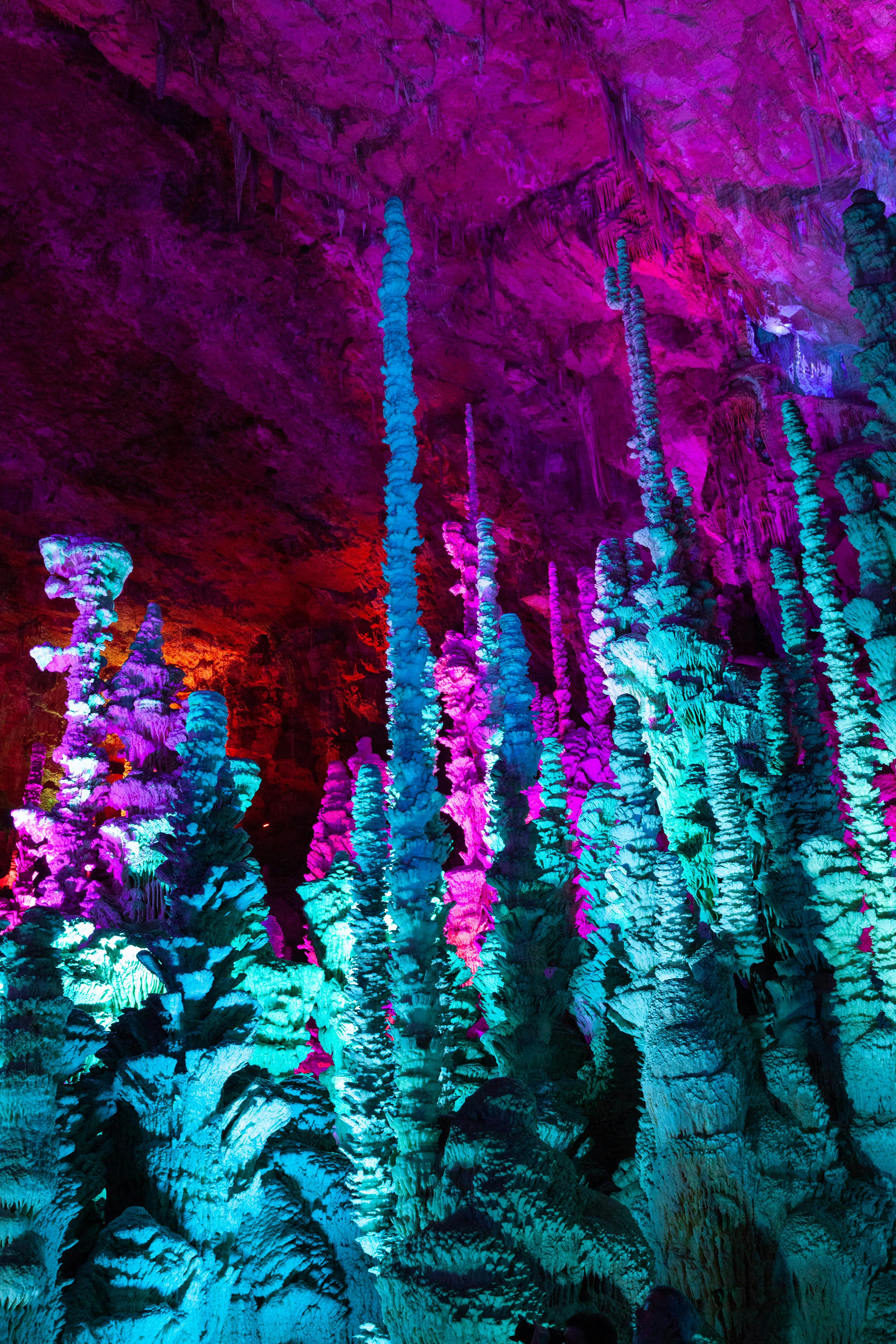 Stalactites in Limestone Cave Illuminated with Purple and Blue Lights ...