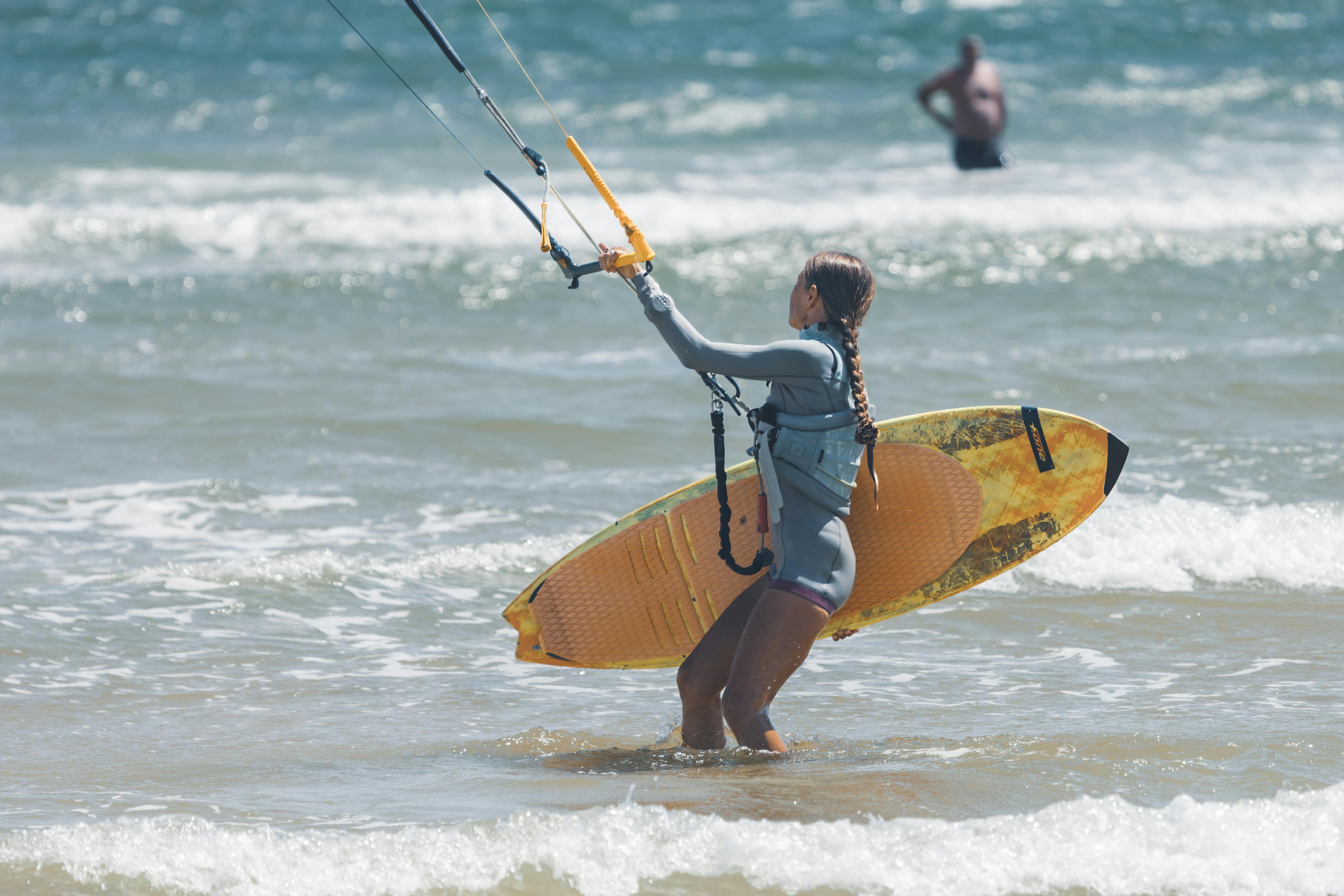 Woman Kitesurfing on Sea Shore · Free Stock Photo