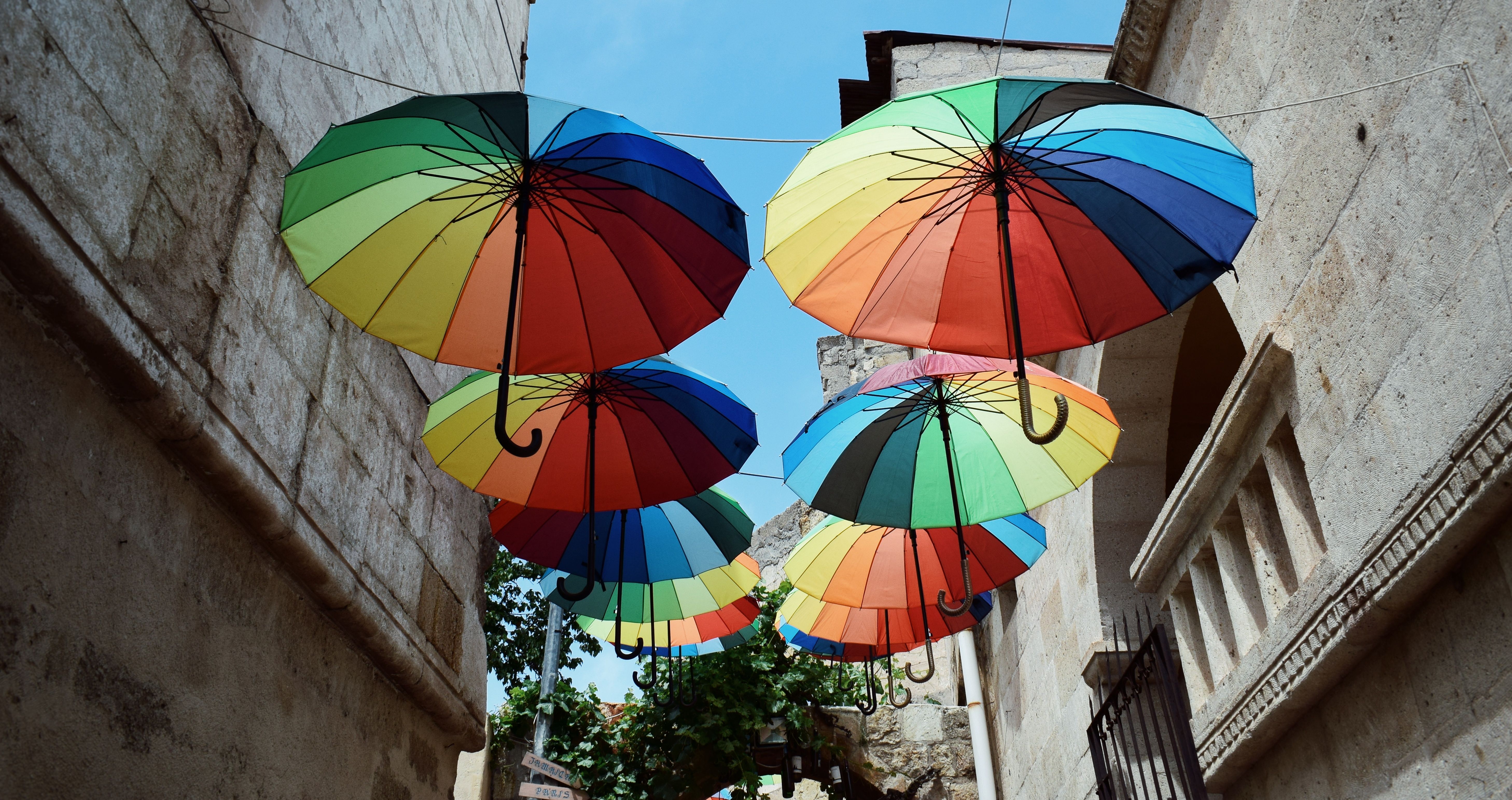 Colorful Umbrellas Hanging above the Street between the Buildings ...