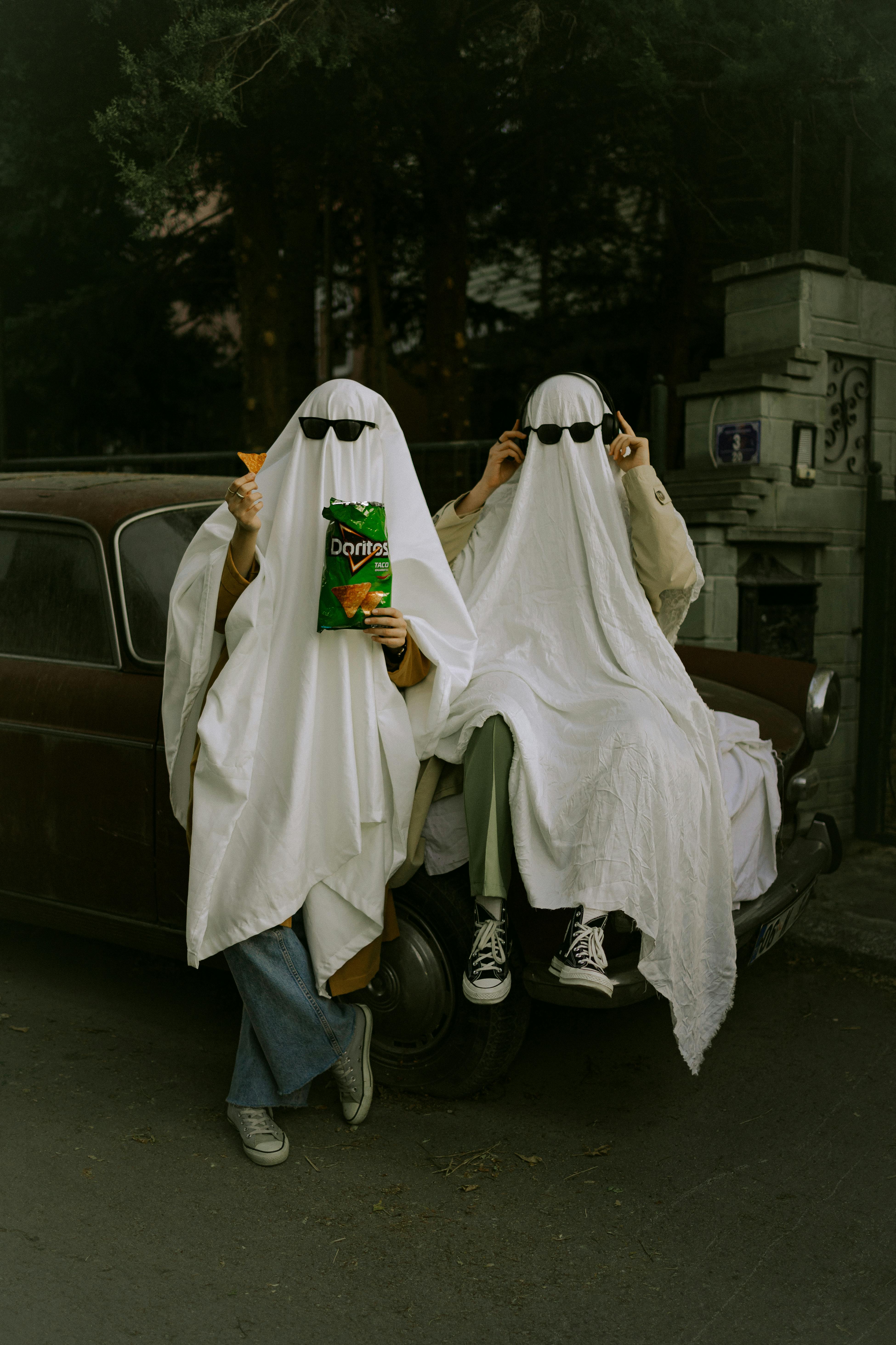 People Dressed as Ghosts Wearing Sunglasses and Eating Crisps · Free ...