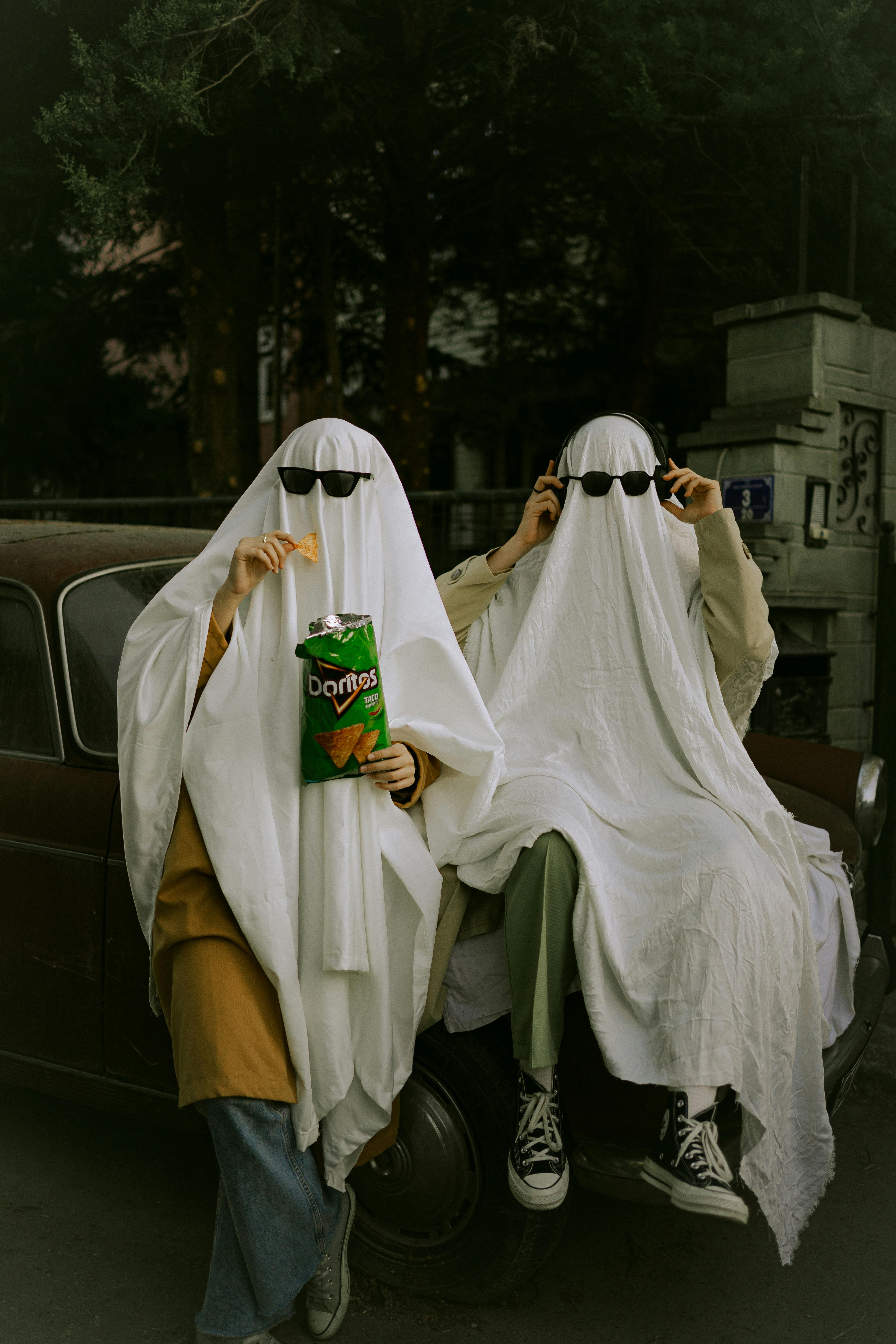 People Dressed as Ghosts Wearing Sunglasses and Eating Crisps · Free ...